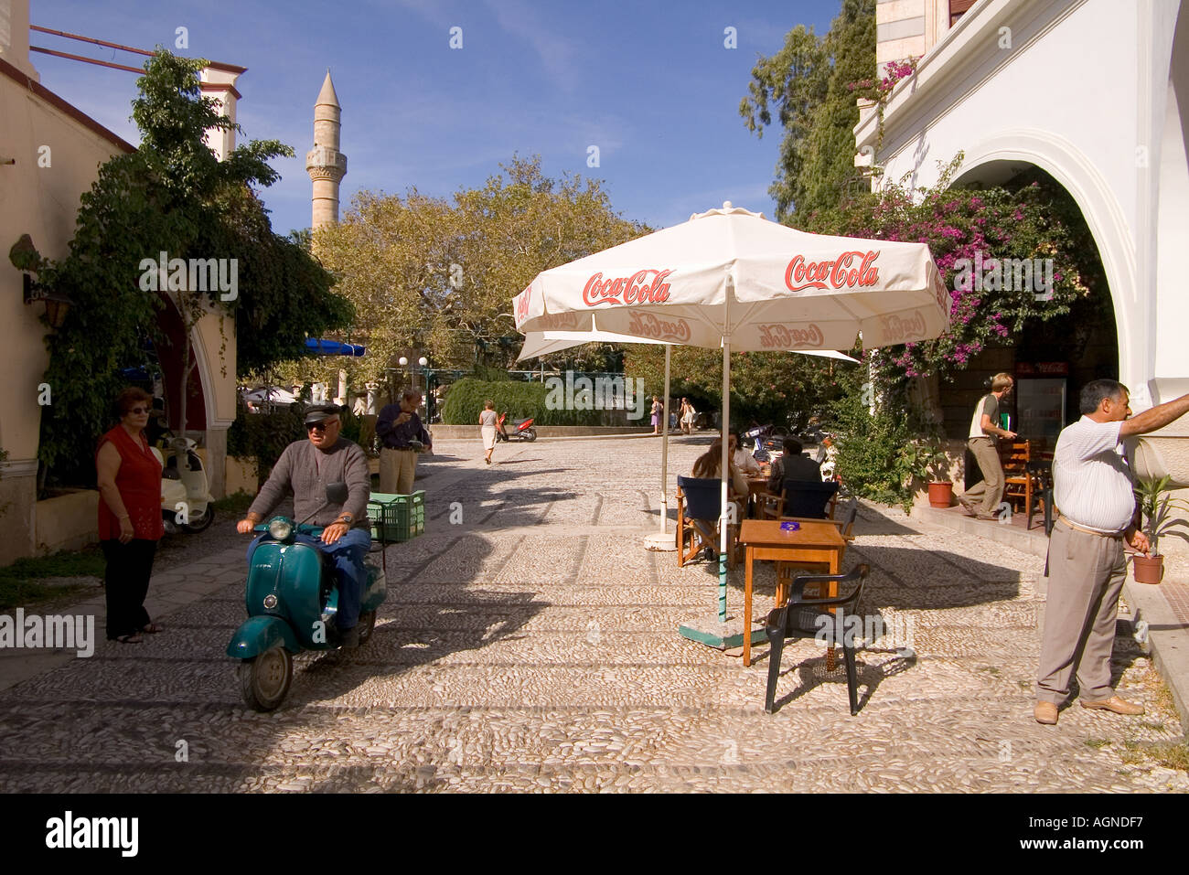 dh KOS TOWN GREECE KOS Cafe tables man on motor bike Plane tree of ...