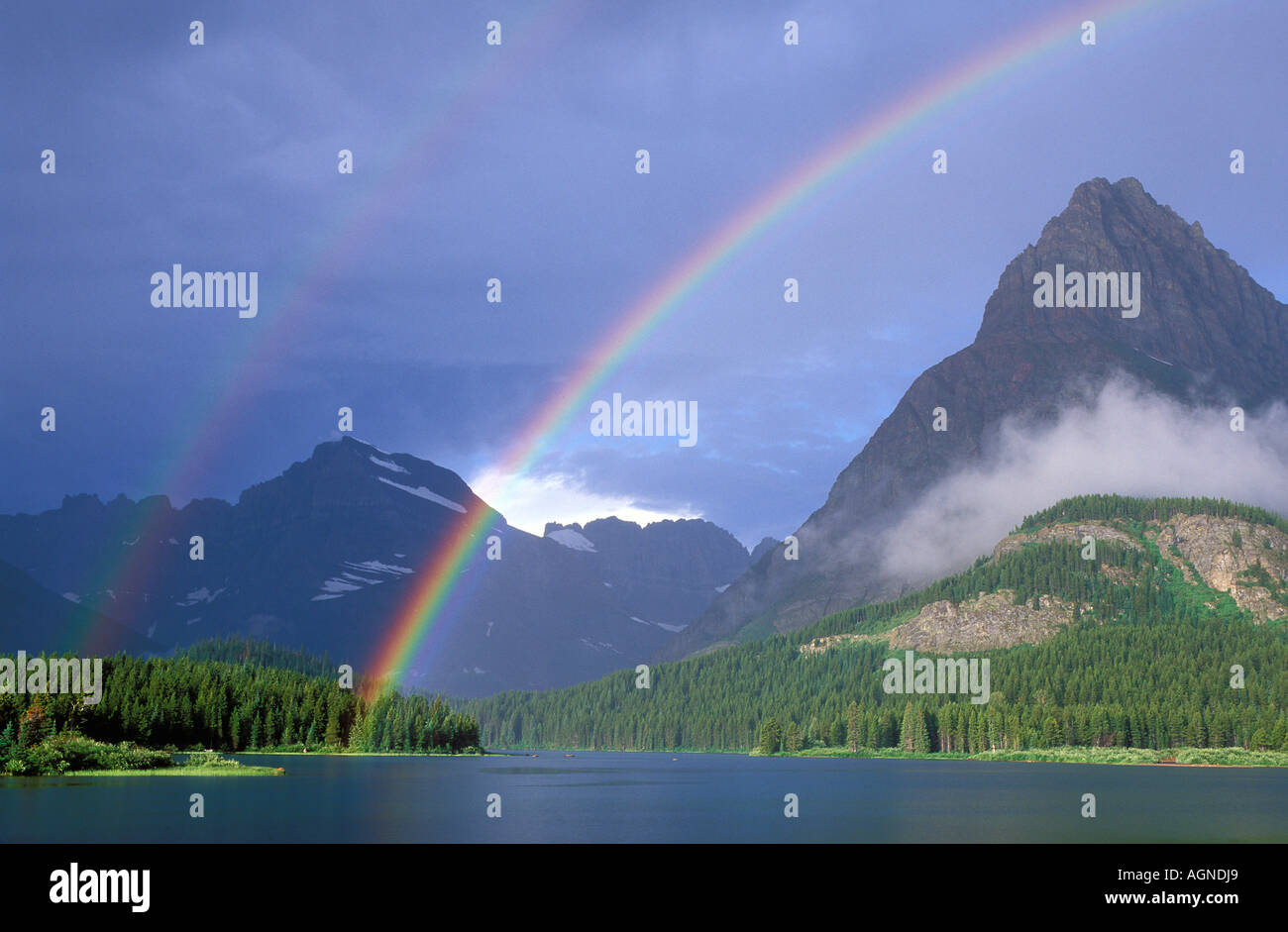 Rainbow over Swiftcurrent lake in Glacier National Park Montana Stock ...