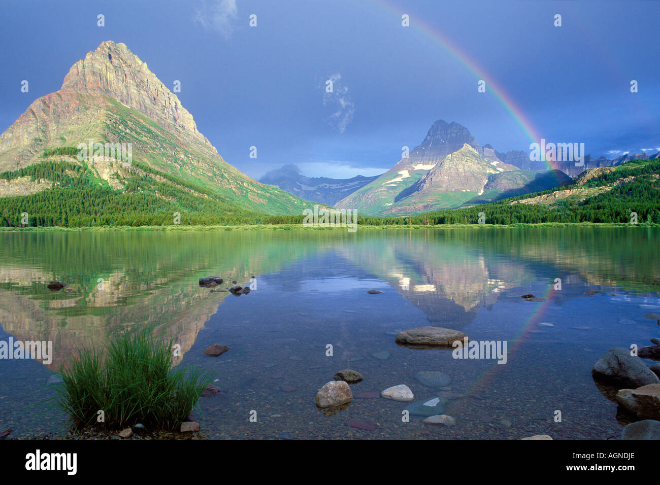 Rainbow over Swiftcurrent lake in Glacier National Park Montana Stock ...