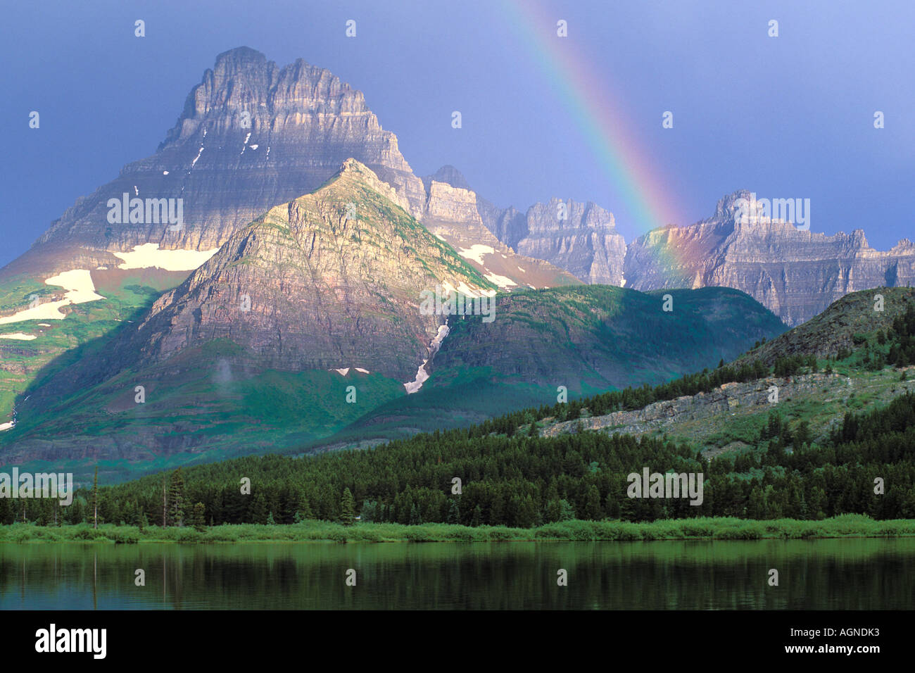 Rainbow over Swiftcurrent lake in Glacier National Park Montana Stock ...