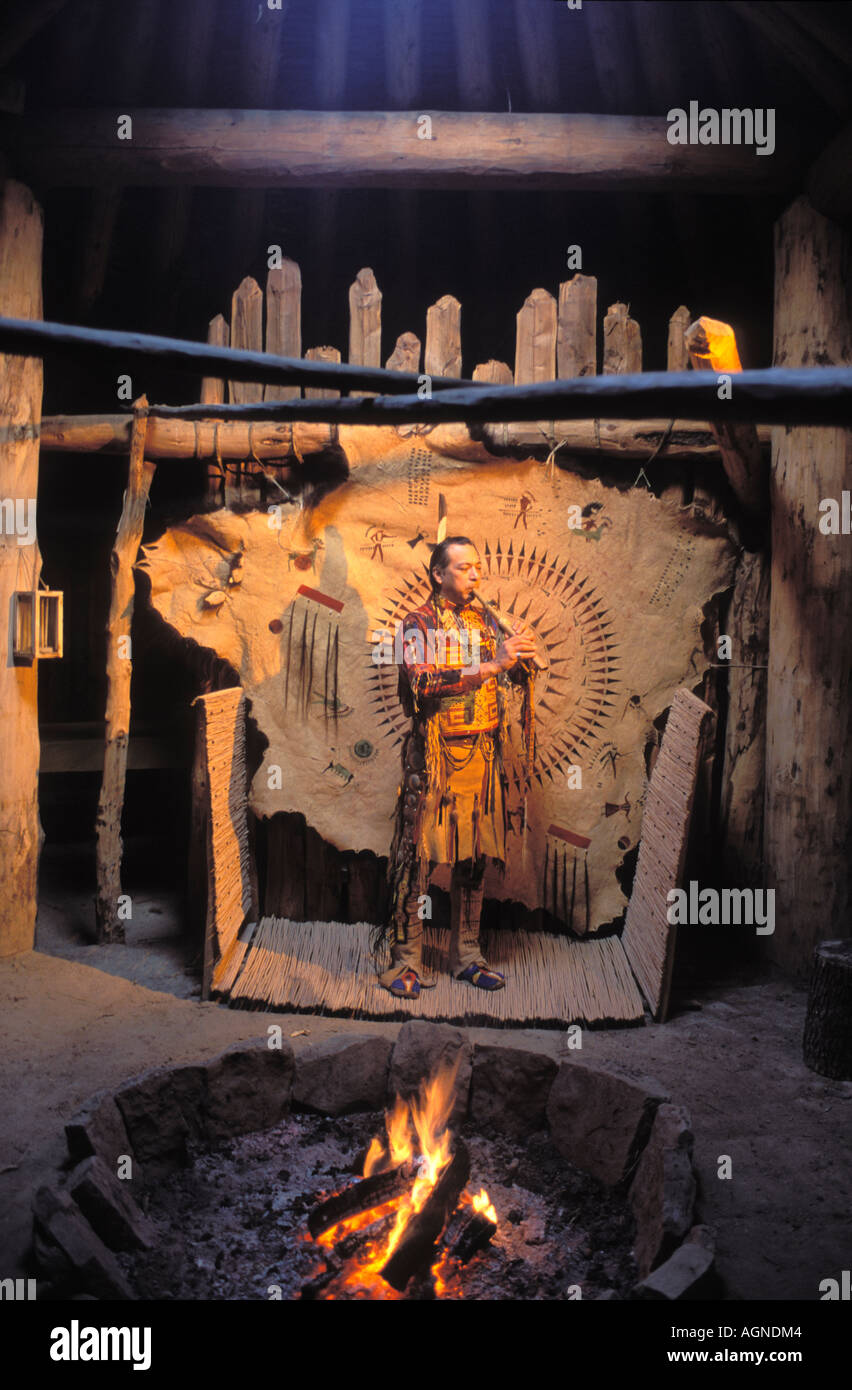 Keith Bear playing a flute in an earthlodge at the Knife River Indian Villages National Historic ...