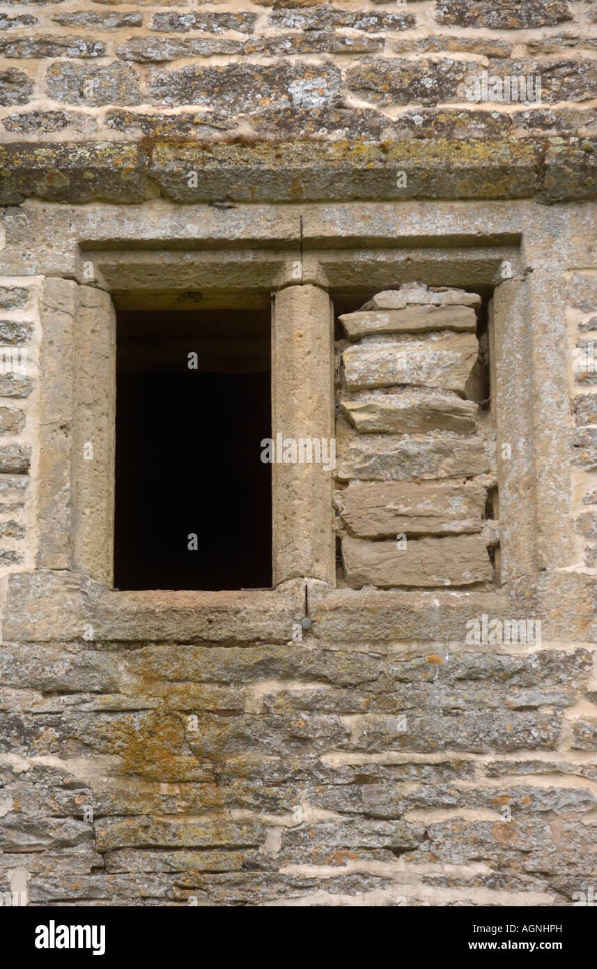 A CRUDELY BLOCKED STONE MULLION WINDOW ON THE DOVECOTE AT NAUNTON ...