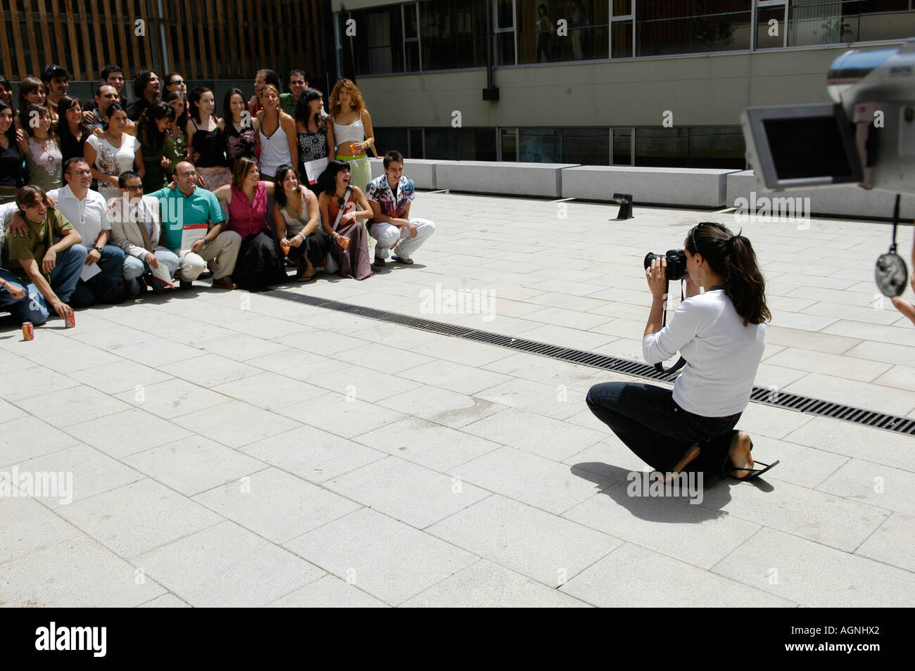 Photographer taking a picture of a college graduation class, in ...