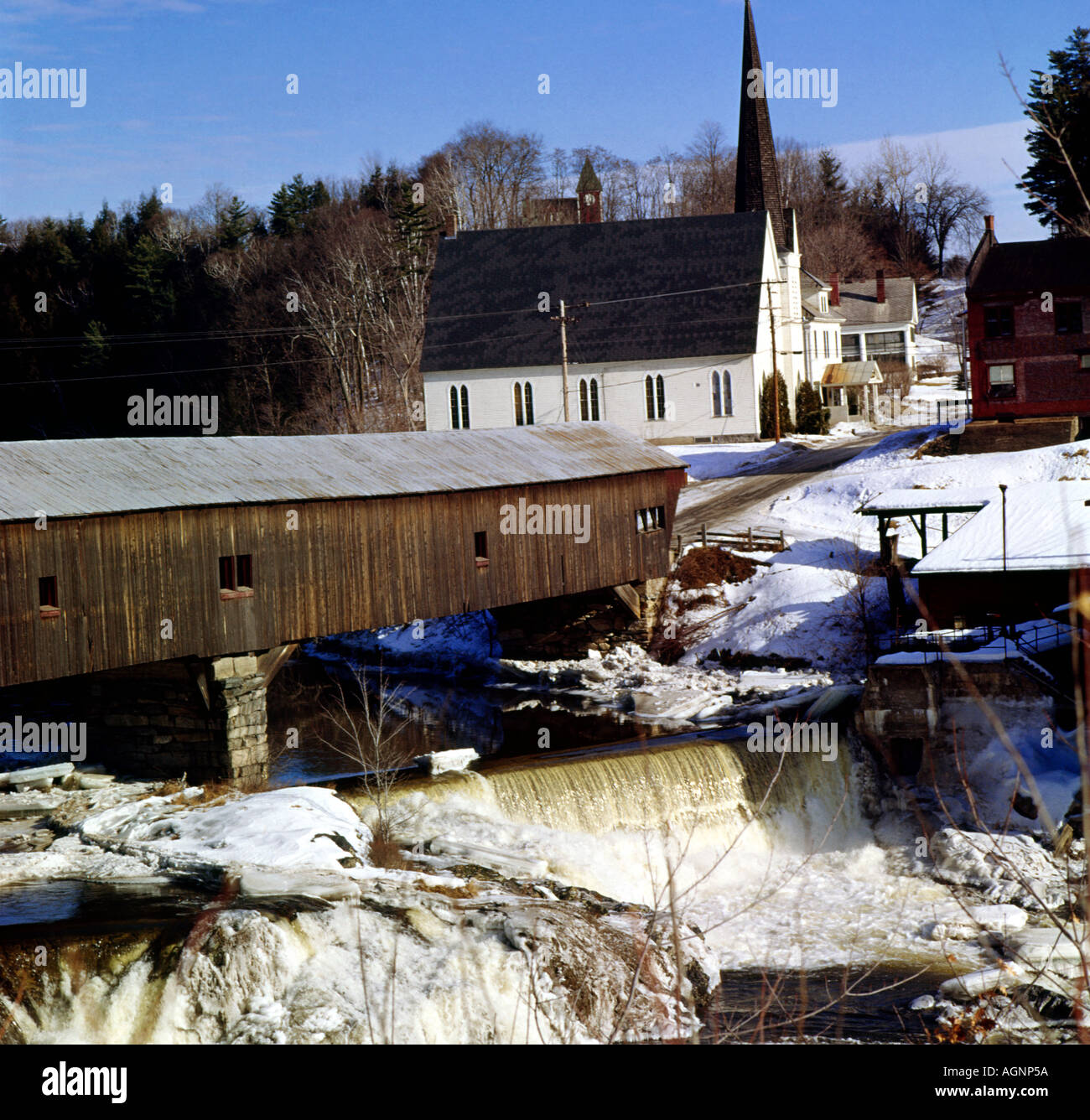 Covered bridge in Bath in New Hampshire spans wide stream next to a ...