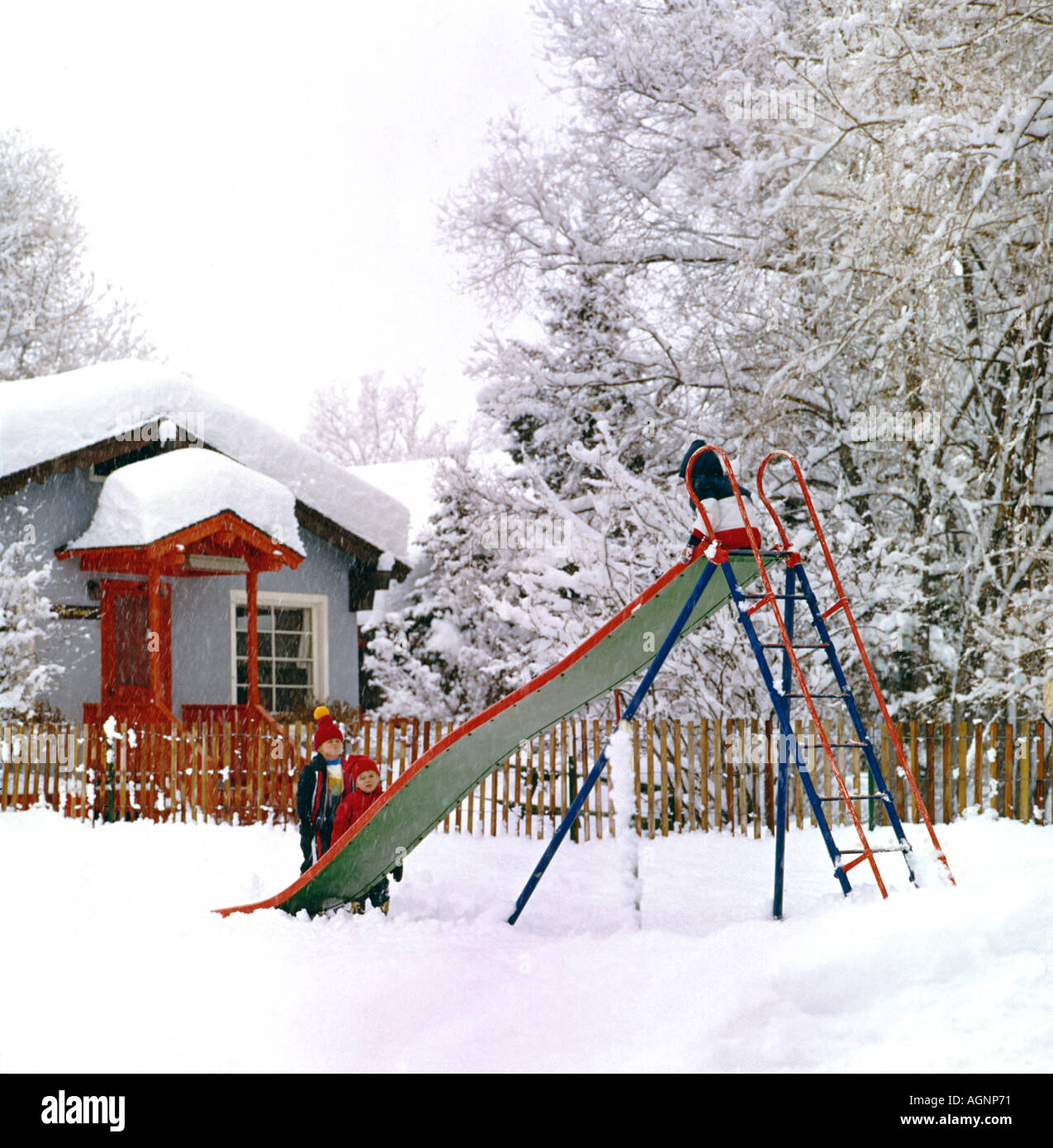 Children playing on a slide on a wintery morning Stock Photo - Alamy