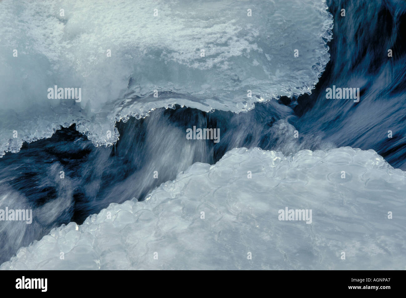 Icy water flows under frozen snow Stock Photo - Alamy