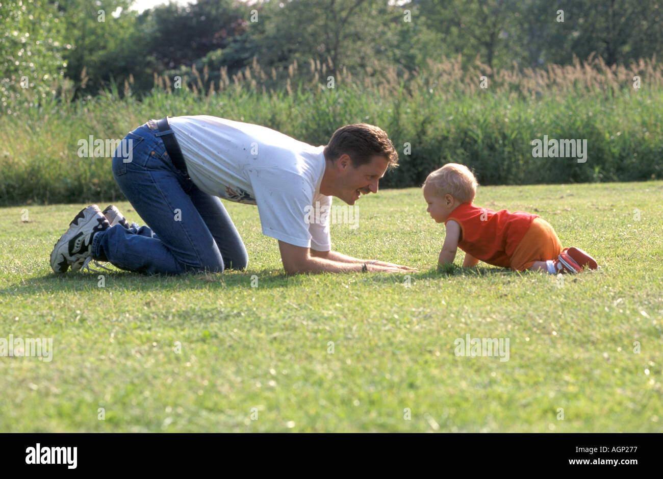 Child crawling grass hi-res stock photography and images - Alamy