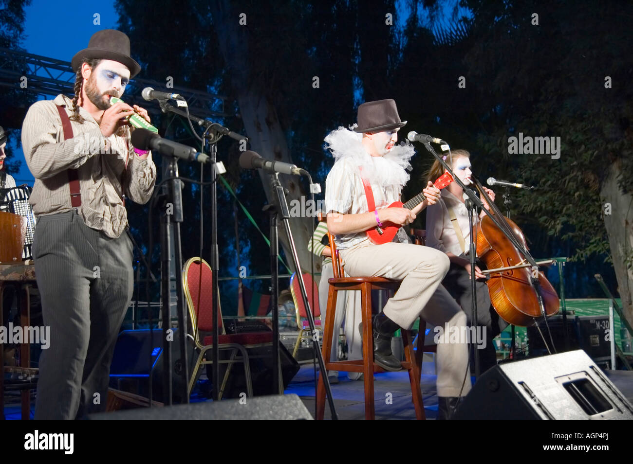 Musicians dressed and made up as clowns playing music on stage Stock ...