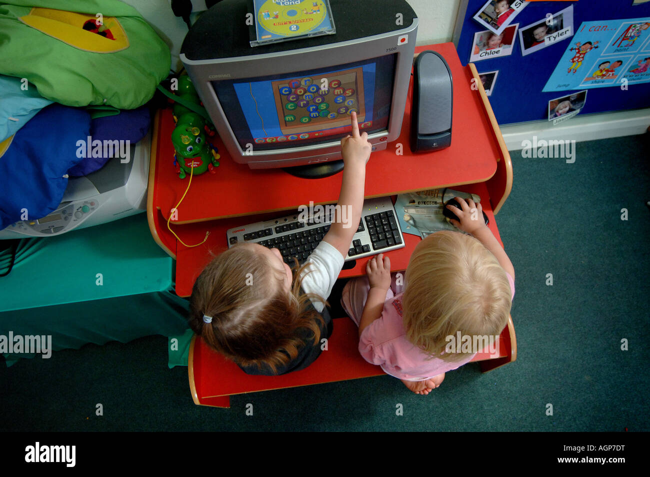 Nursery children playing games on a computer Stock Photo - Alamy
