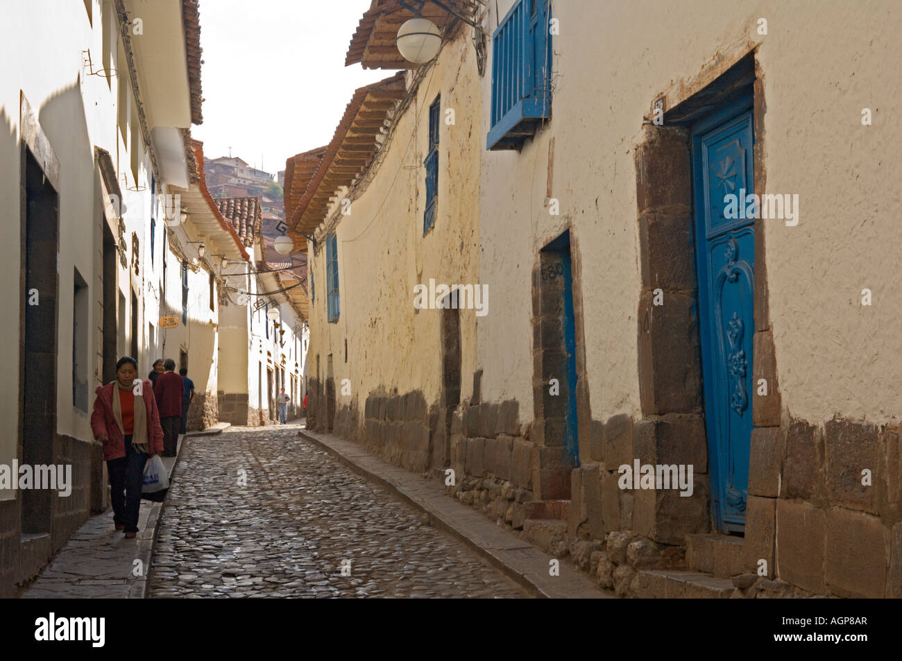 Peru, Cusco, Street scene of buildings and people walking on sidewalk ...
