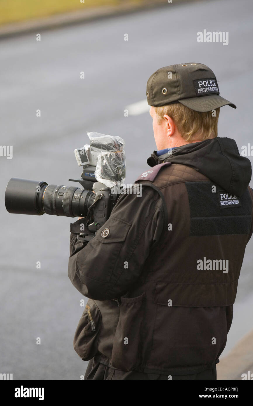 A police photographer photographs protestors at the camp Stock Photo ...
