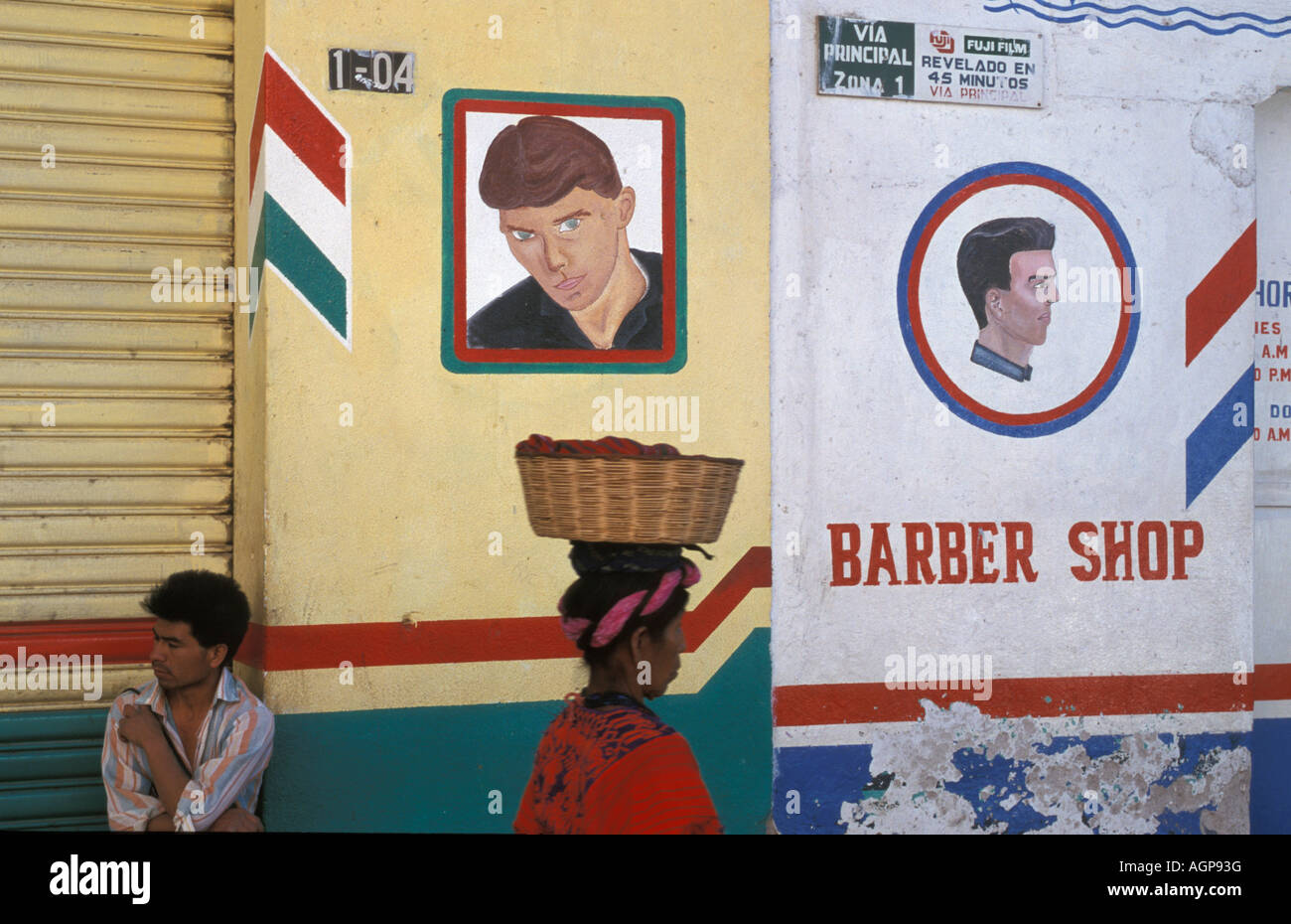 Guatemala Panajachel Woman with basket walking by barber shop Stock ...