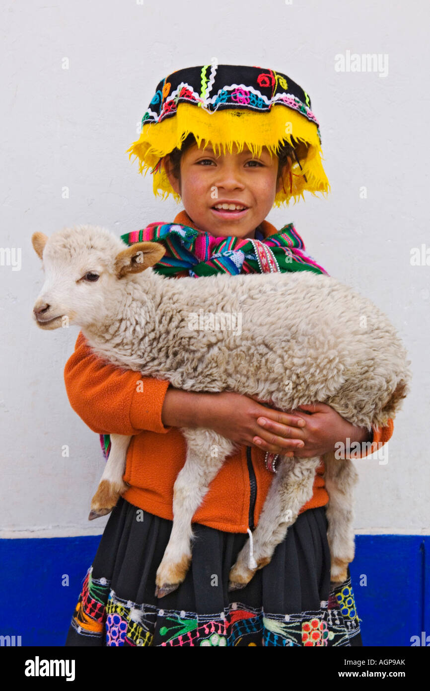 Peru, Pisac, Portrait of girl in native dress holding lamb Stock Photo ...