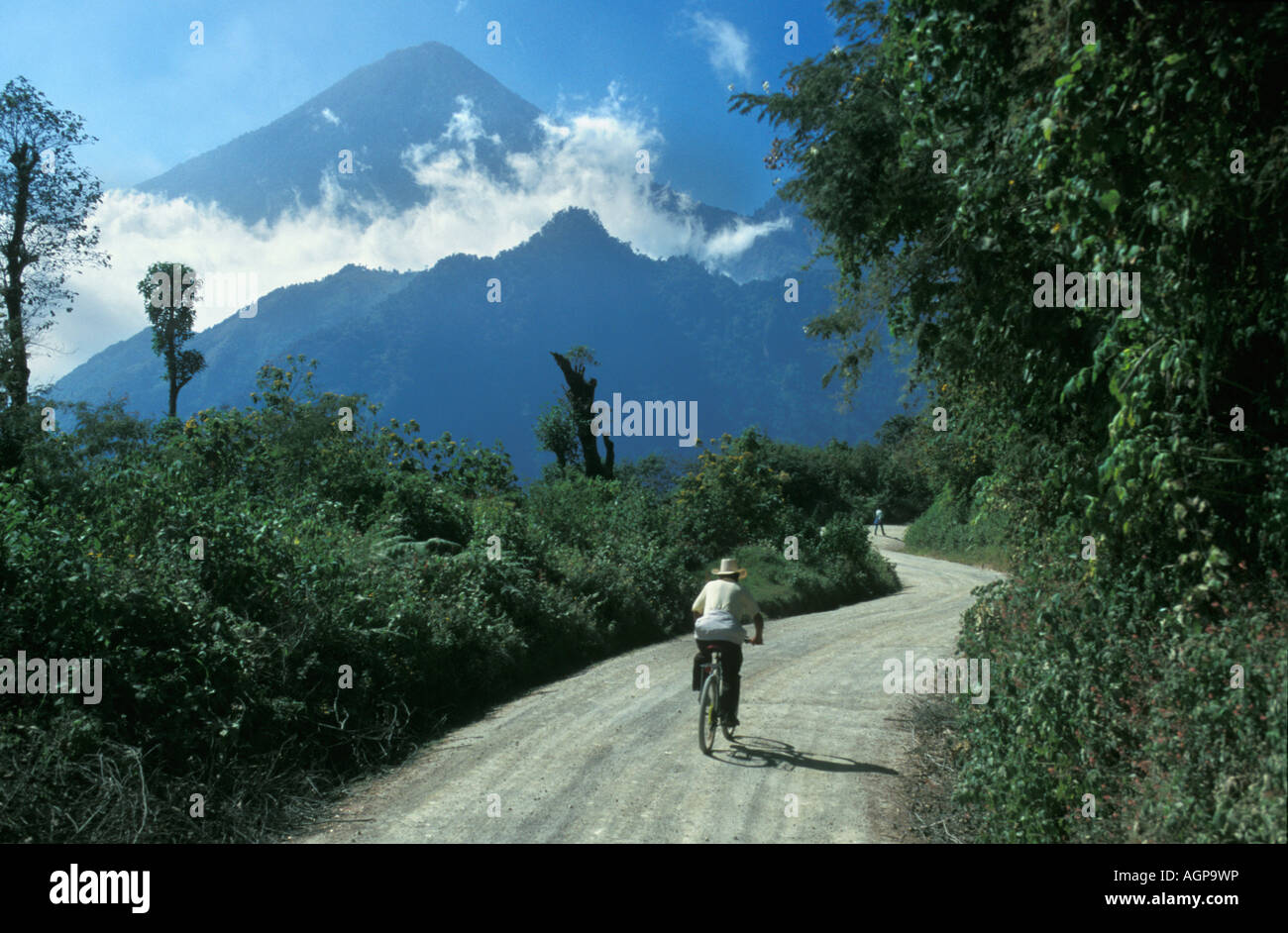 Guatemala, San Francisco el Alto, Man on bicycle with volcano in ...