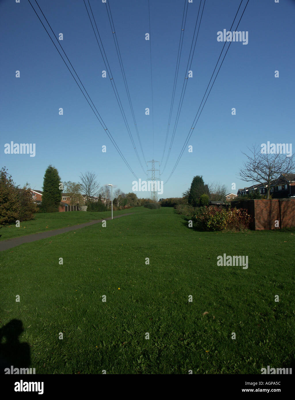 Pylons running through housing estate Stock Photo - Alamy