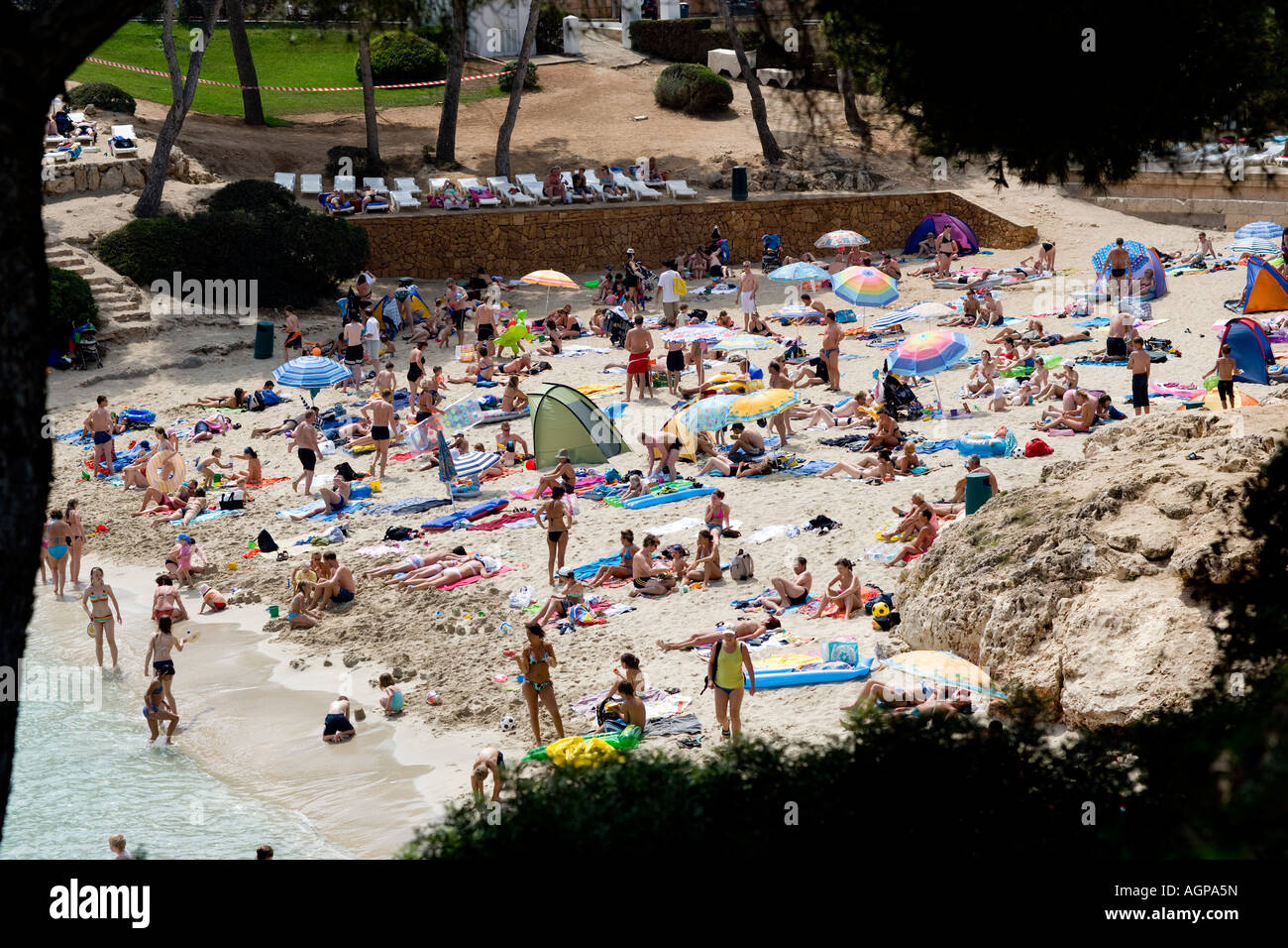 Beach full of sunbathing people Stock Photo - Alamy
