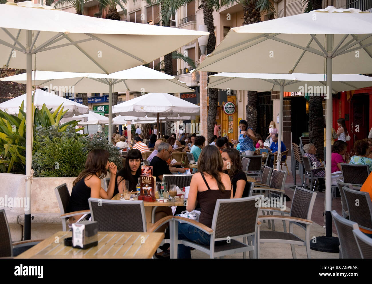 People seating outside of a bar in Alicante Stock Photo - Alamy