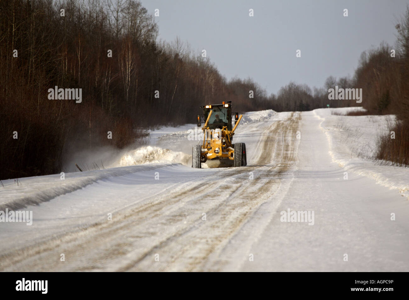 Road grader clearing snow in Northern Saskatchewan Stock Photo - Alamy