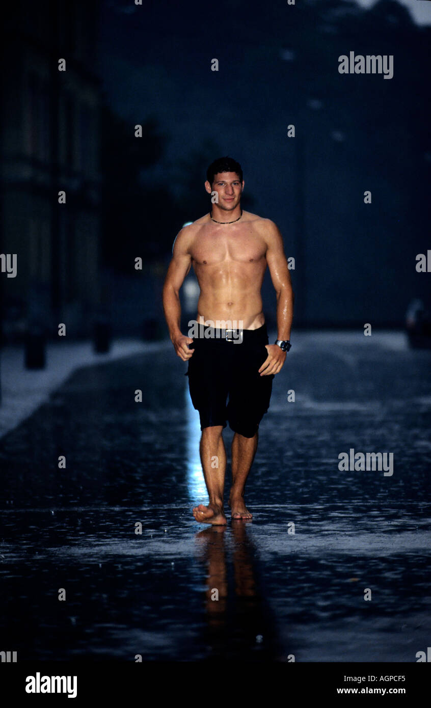 Man walking in evening rain hi-res stock photography and images - Alamy