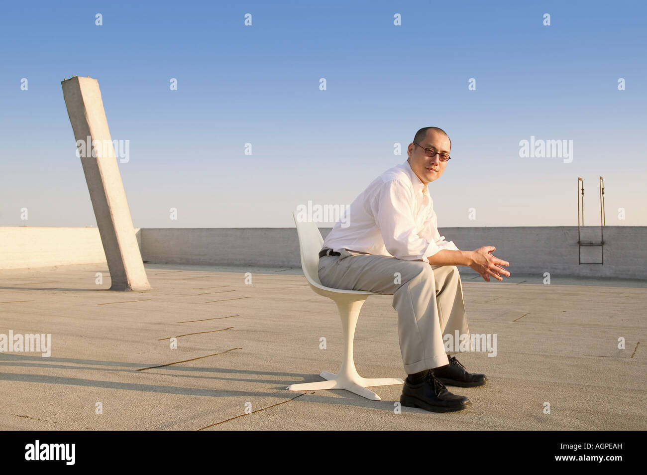 Man Sitting on Rooftop Stock Photo - Alamy