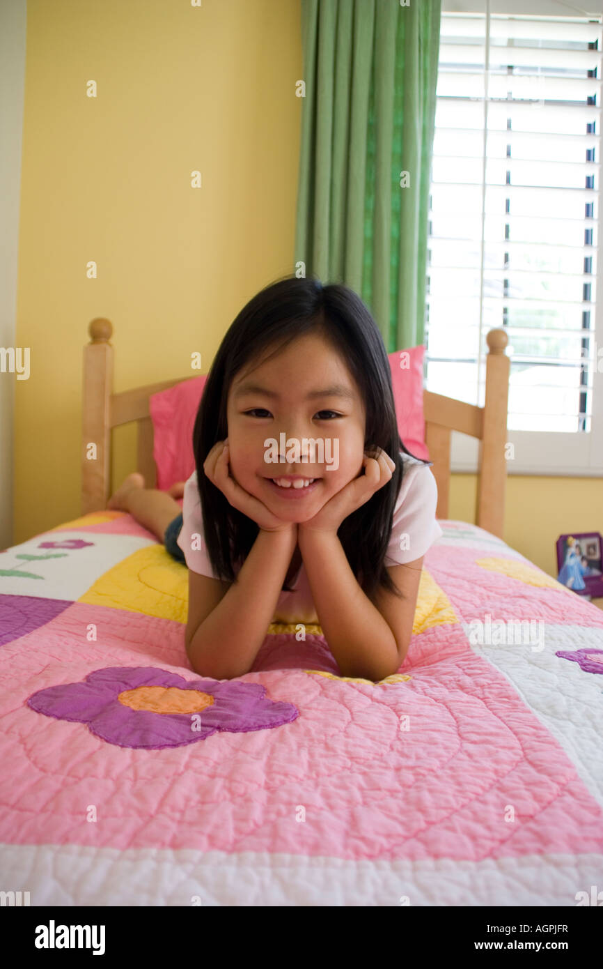 Young Girl Laying in Bed Stock Photo - Alamy