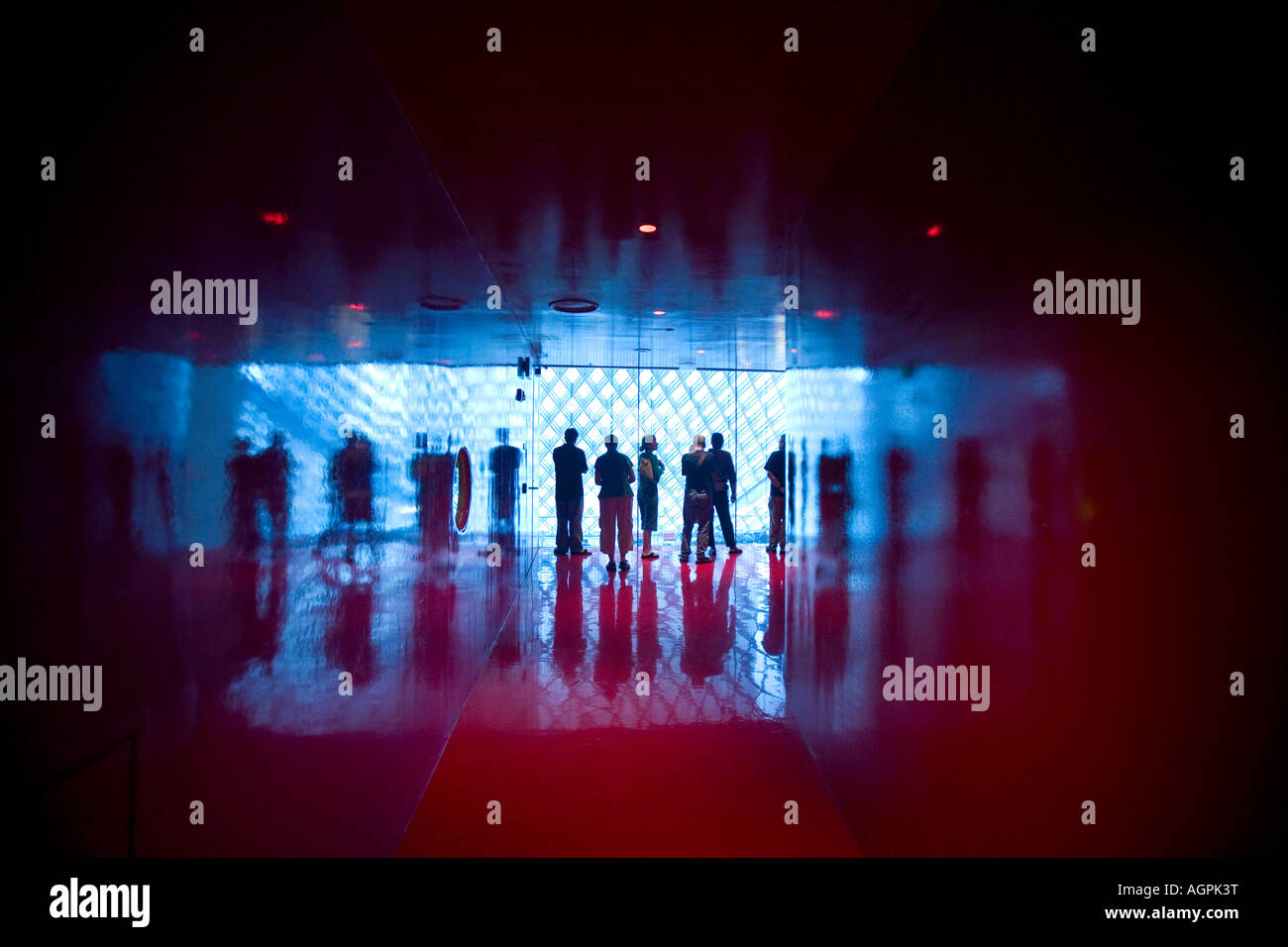 People looking out at the end of a red hallway in the Seattle Public ...