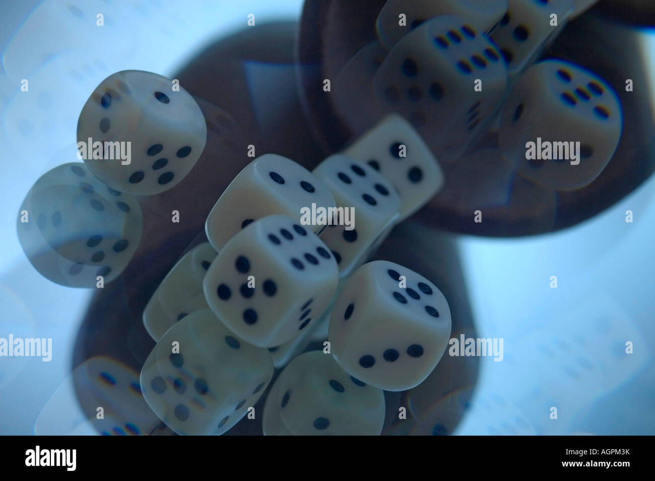 playing with dices and dice shaker on mirror Stock Photo - Alamy