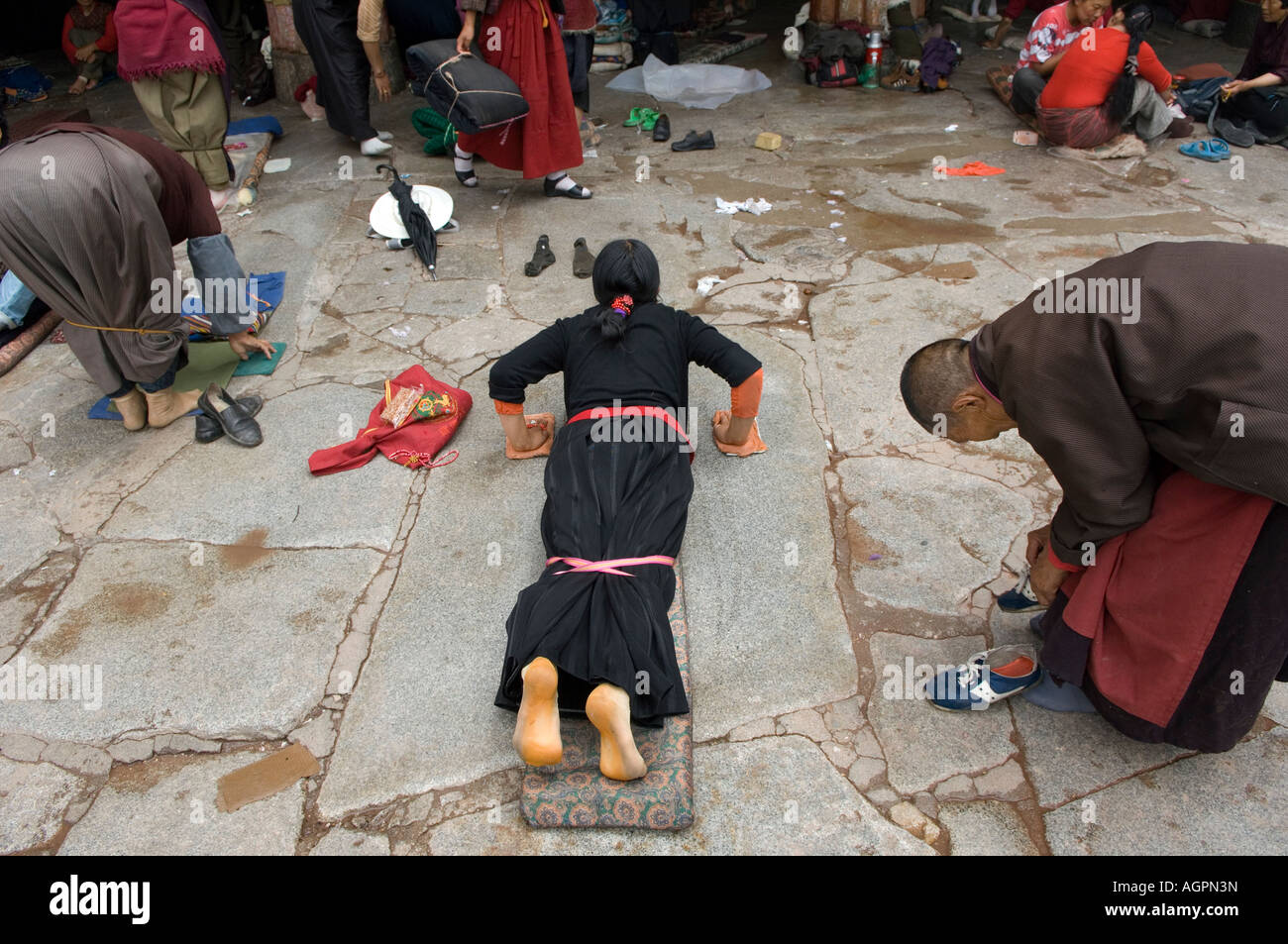 TIBET China Lhasa Buddhist pilgrims pray and prostrate themselves in ...
