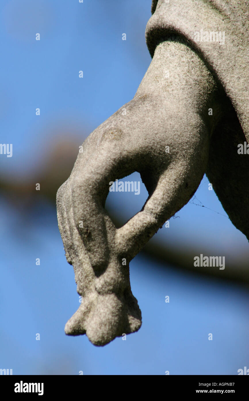 Highgate Cemetery London detail of an angel figurehead holding a flower ...