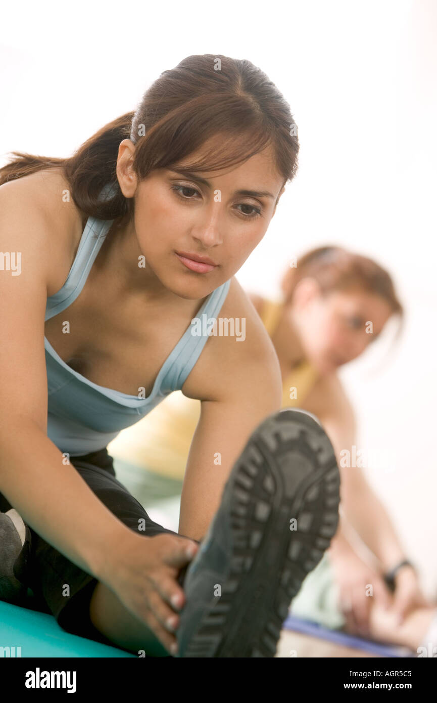 Two women stretching Stock Photo - Alamy