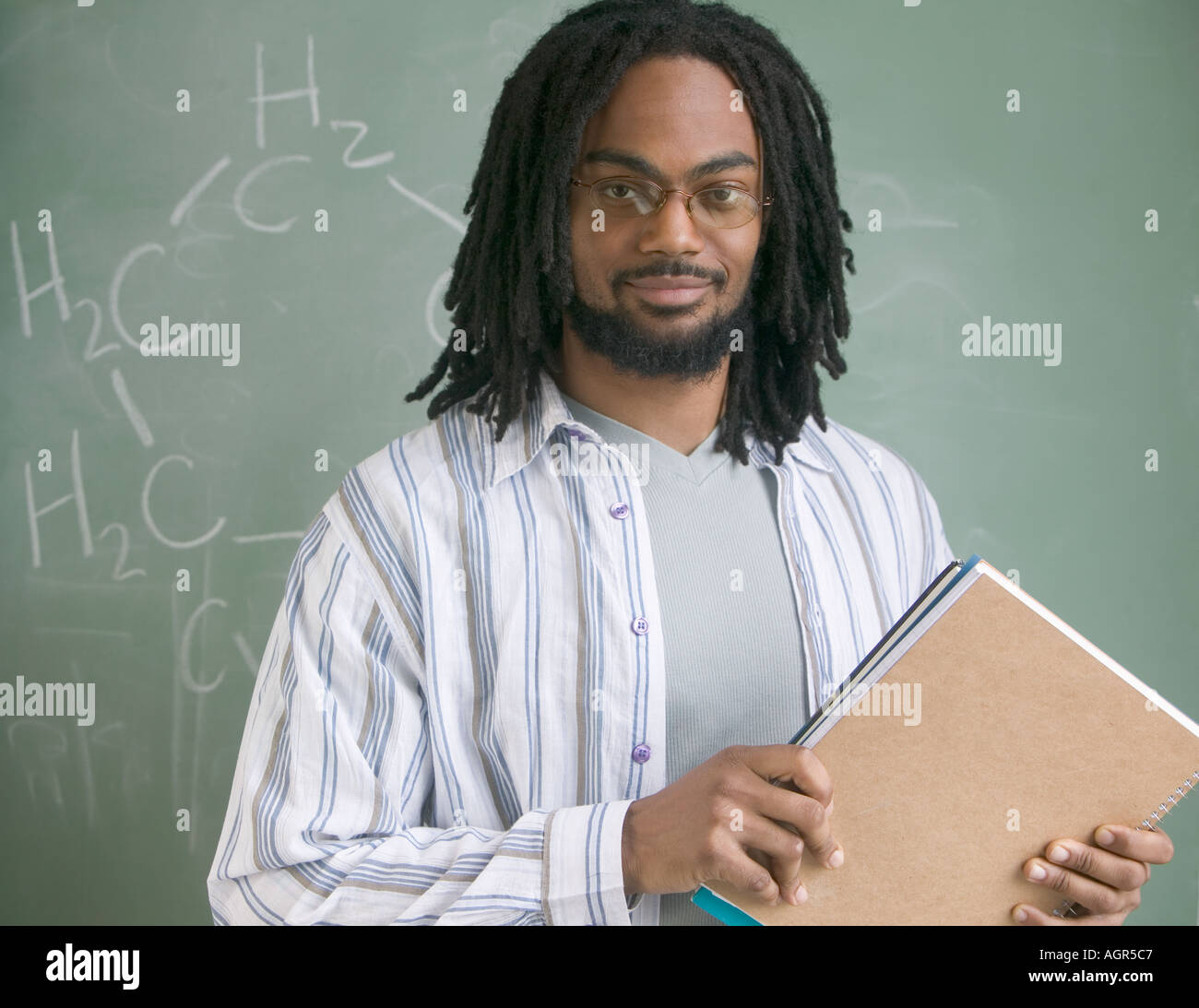 Portrait of male teacher with notebooks Stock Photo - Alamy