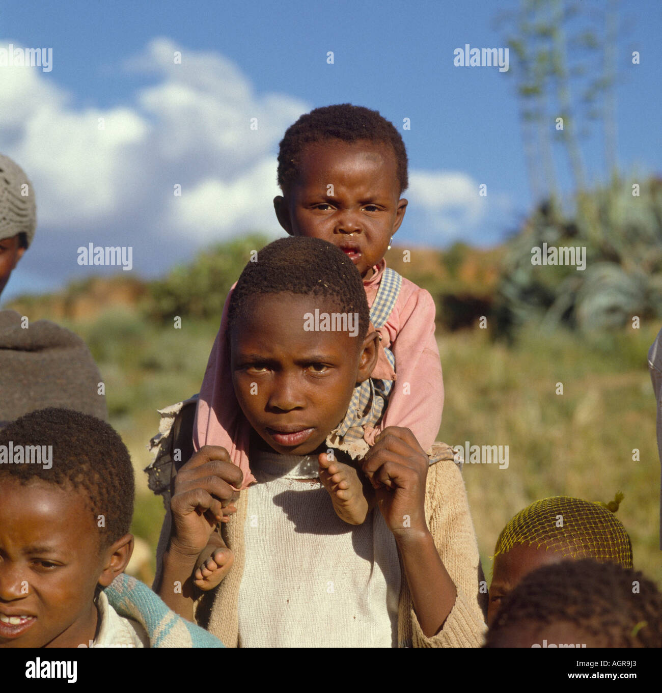 Boy carrying little child Stock Photo - Alamy