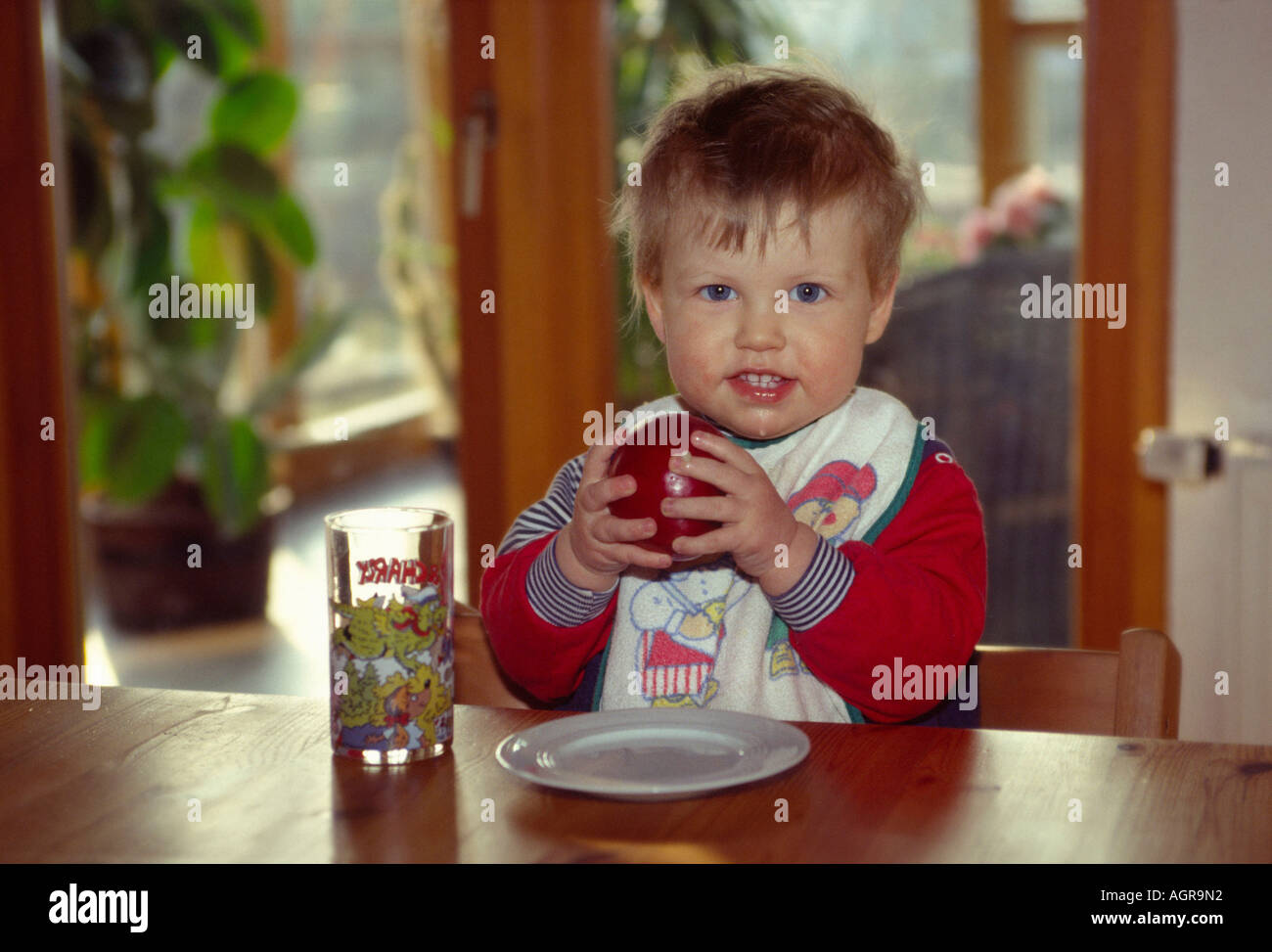 Child eating apple Stock Photo - Alamy