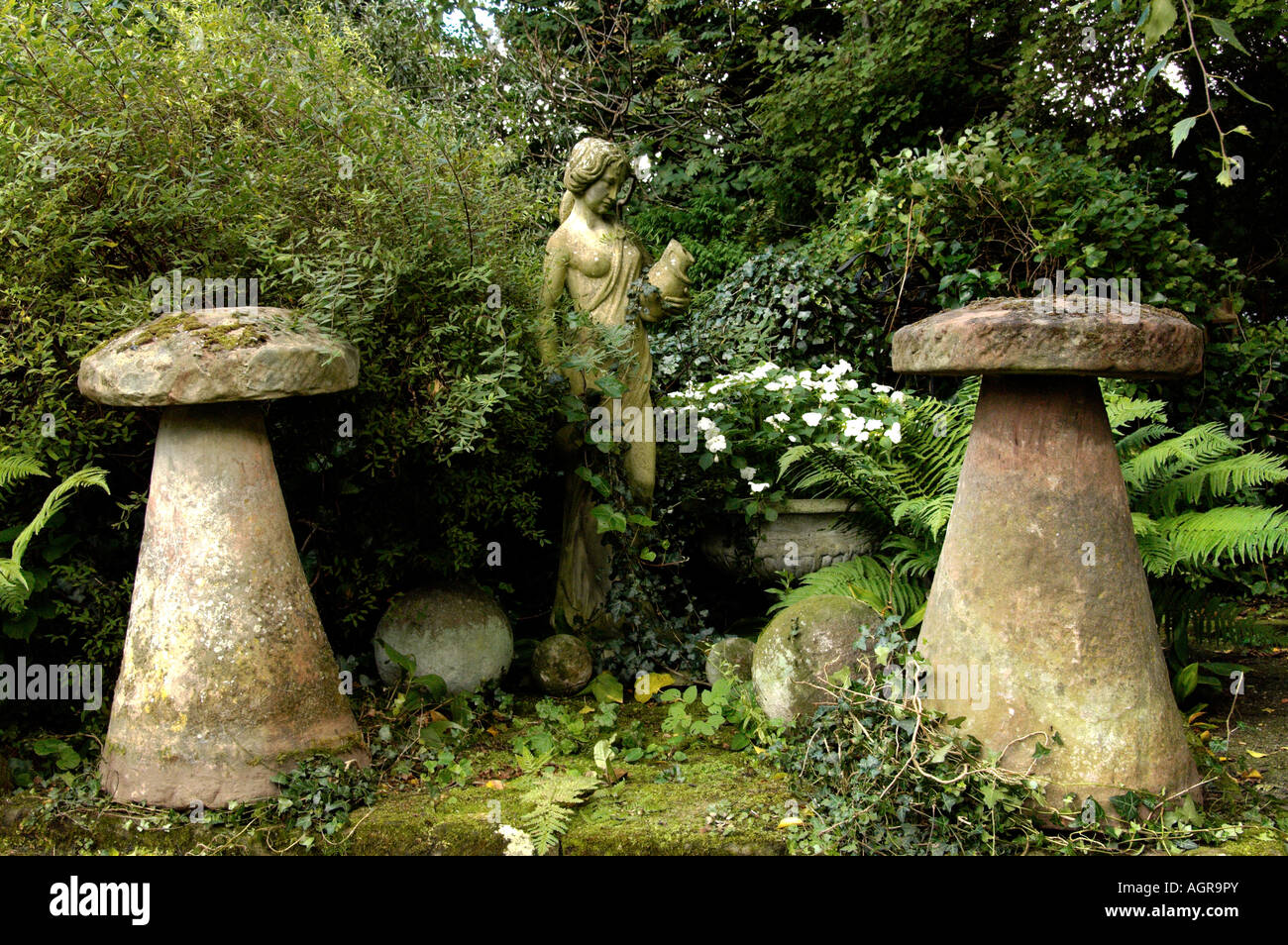 A pair of Georgian Staddle Stones in an English Garden Stock Photo - Alamy