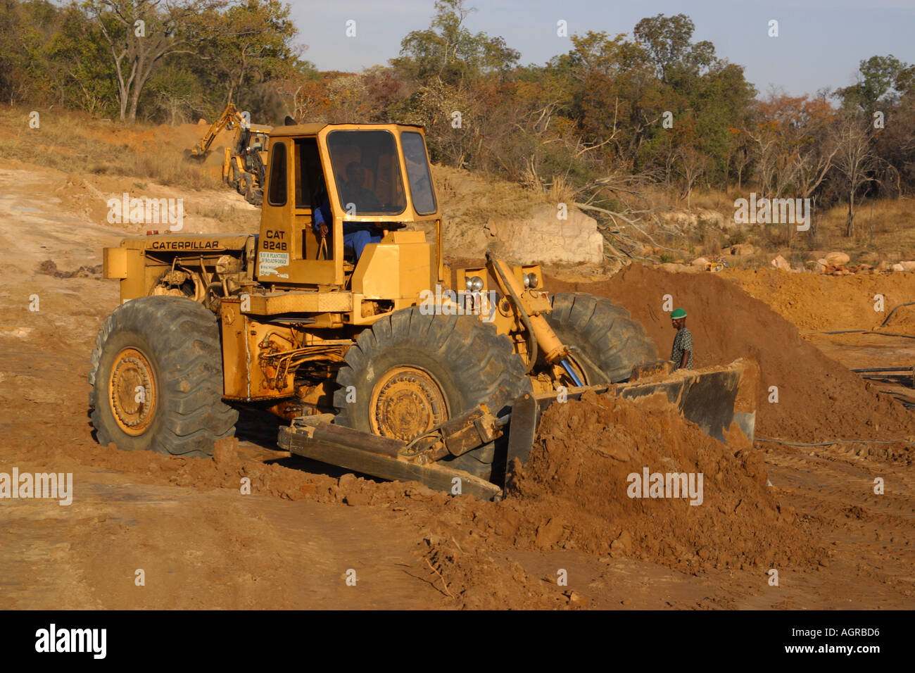 Earth mover tractors working dam building Stock Photo - Alamy