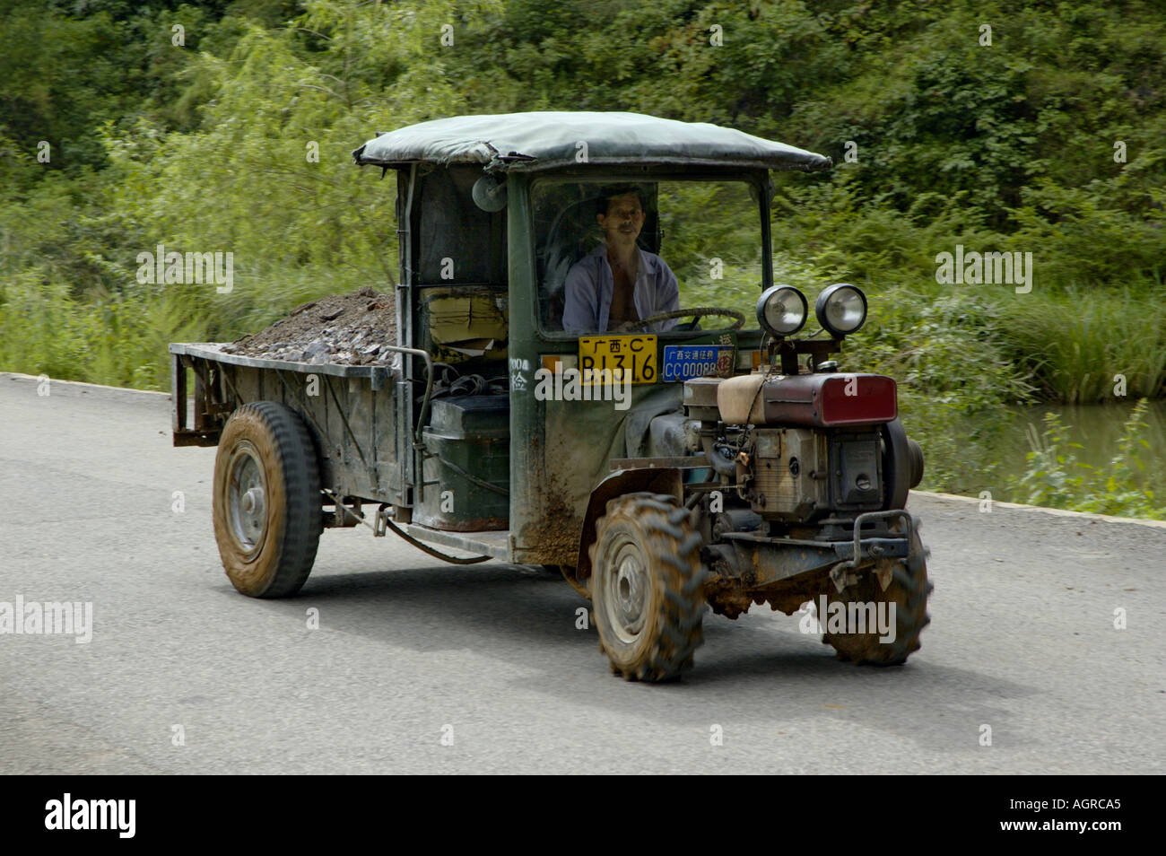Man riding a tractor on a country road, Yangshuo, Guangxi, China Stock ...