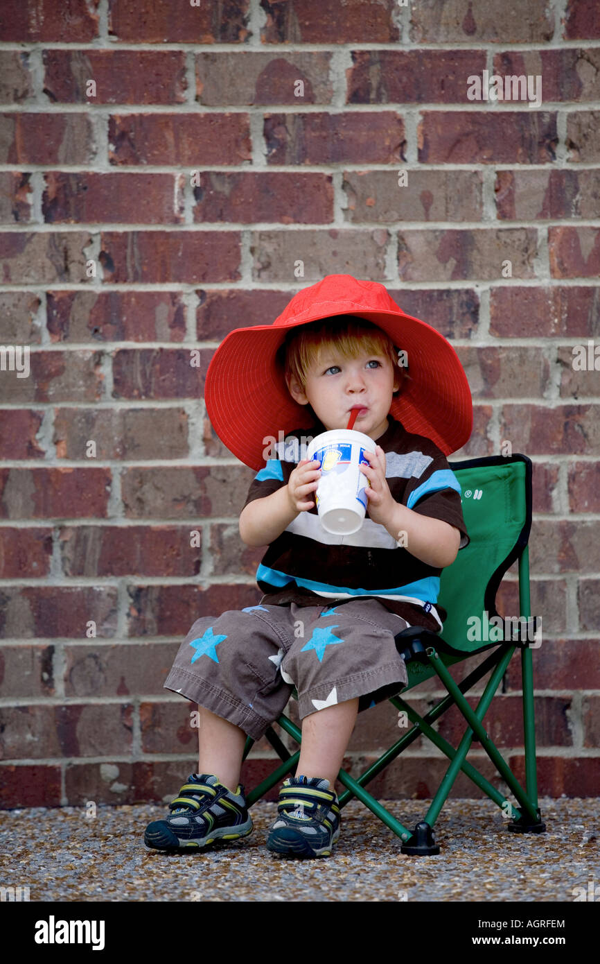 Little boy relaxing with a drink Stock Photo - Alamy