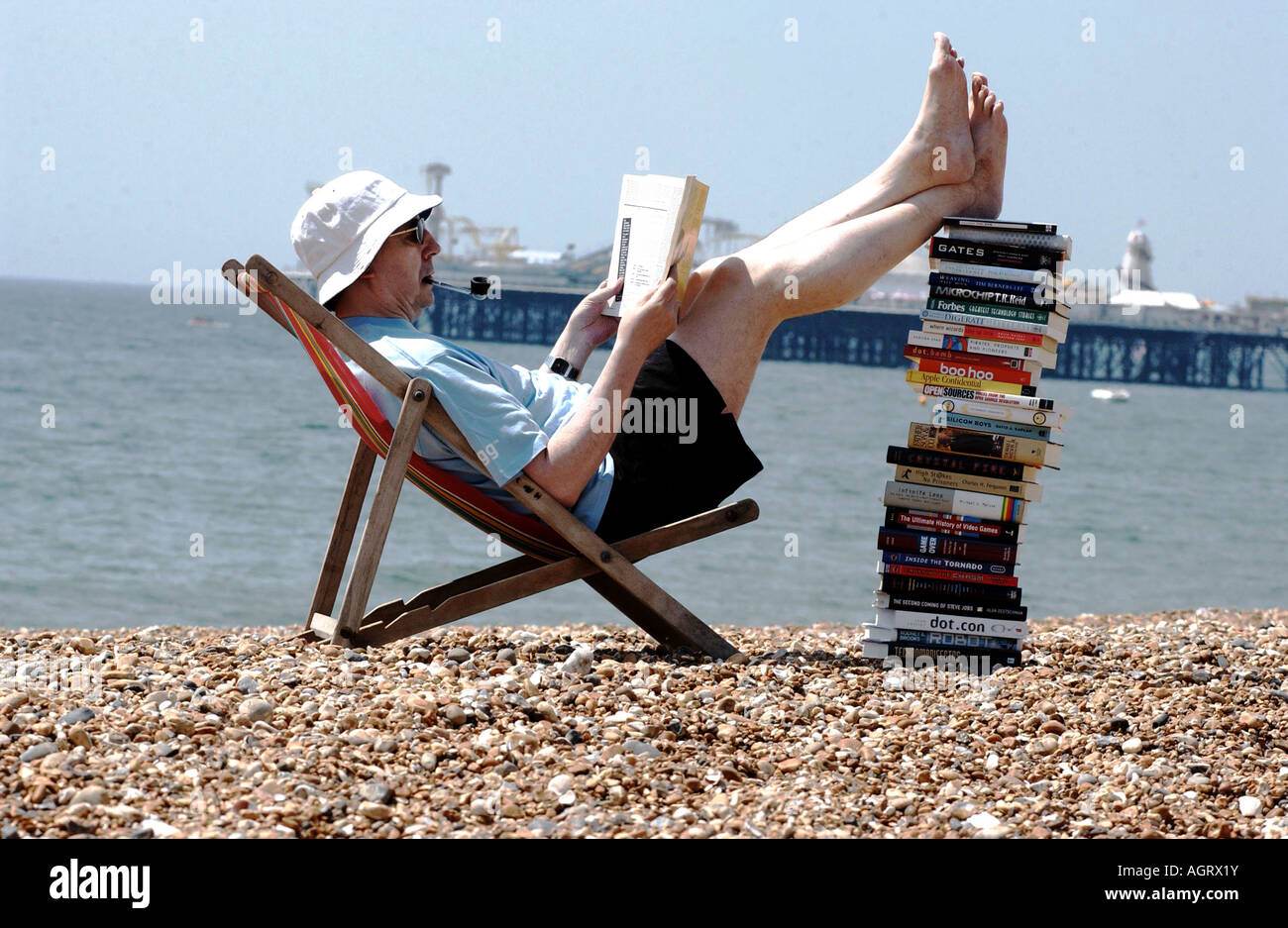 Serious summer reading for a man with a stack of technical books on ...