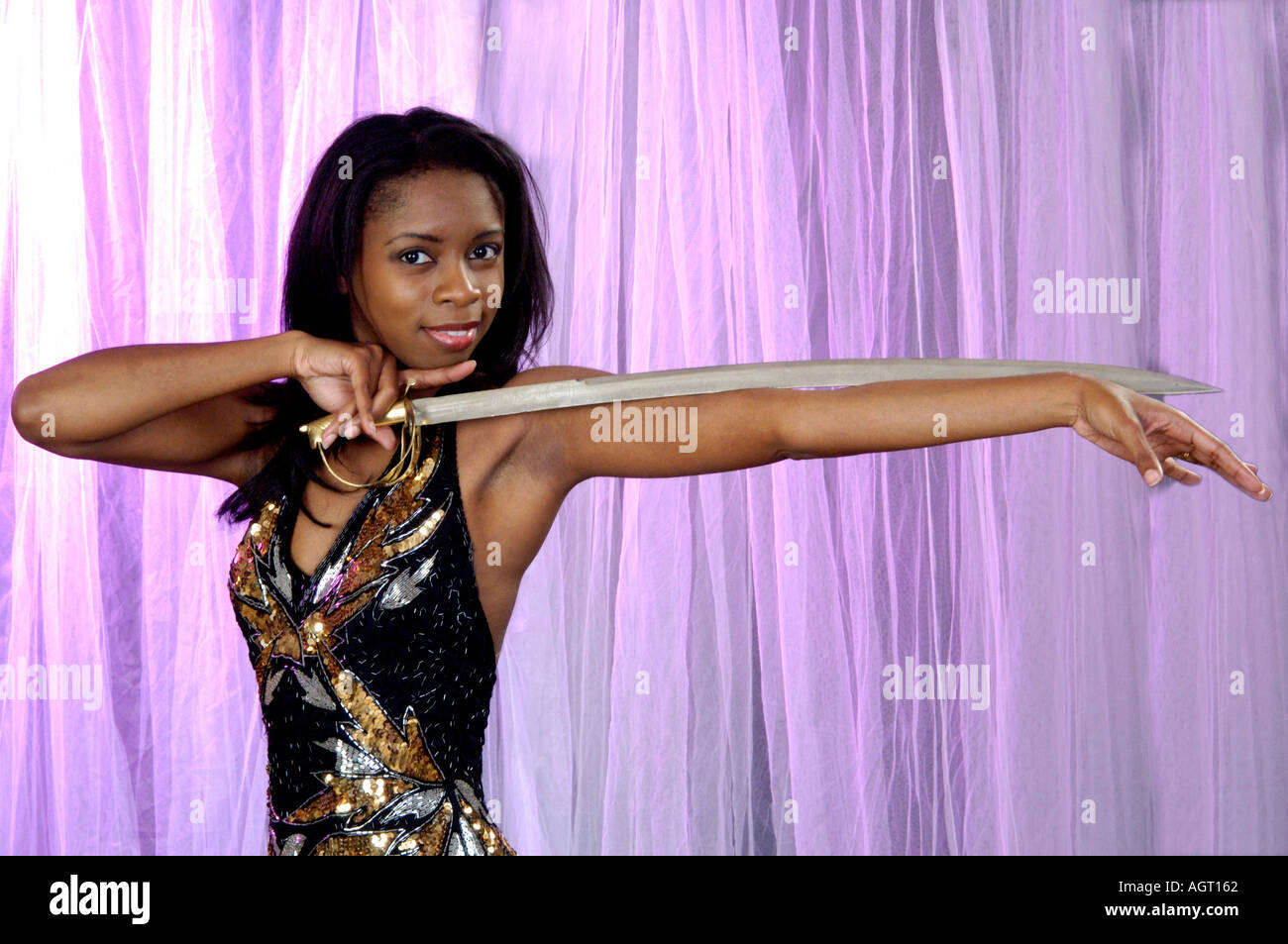 Beautiful belly dancer with a sword Stock Photo - Alamy