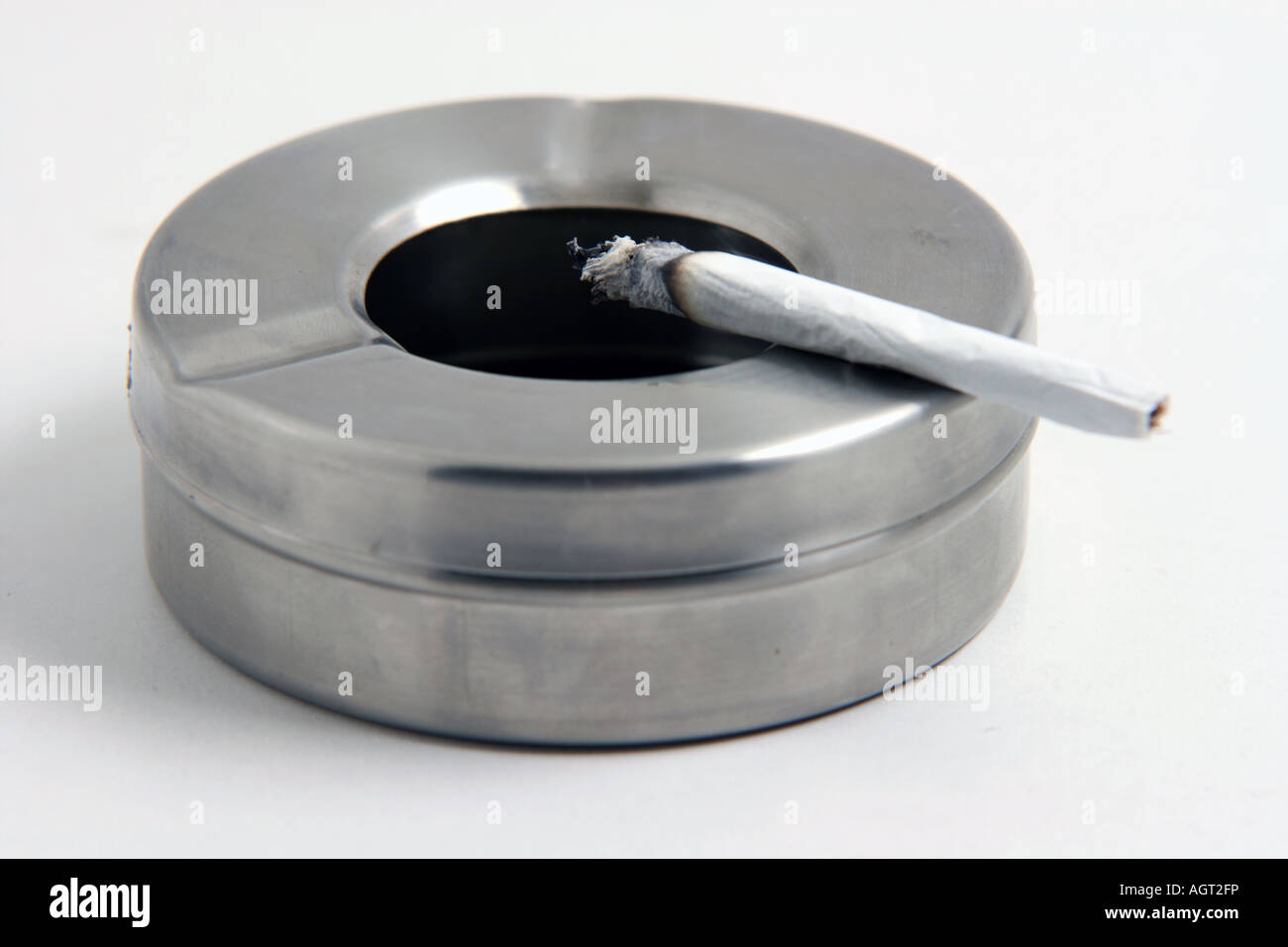 ashtray and cigaret on fire unhealthy habits Stock Photo - Alamy