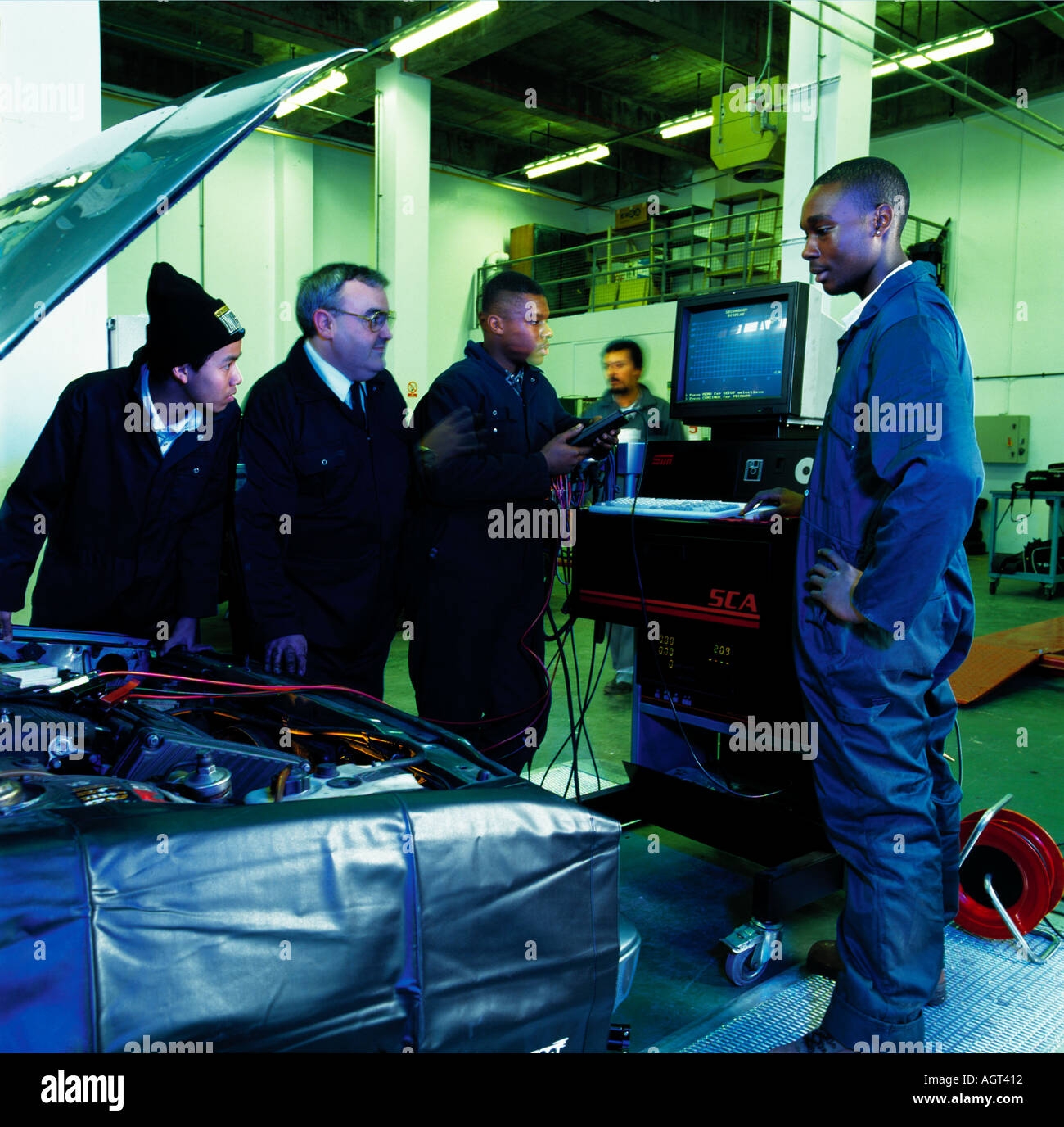 Male car mechanics in role model teaching Stock Photo - Alamy