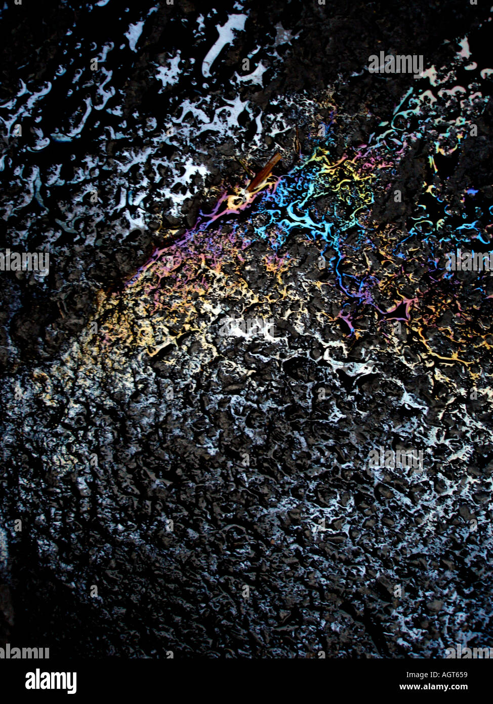 Oil slick on wet pavement Stock Photo - Alamy