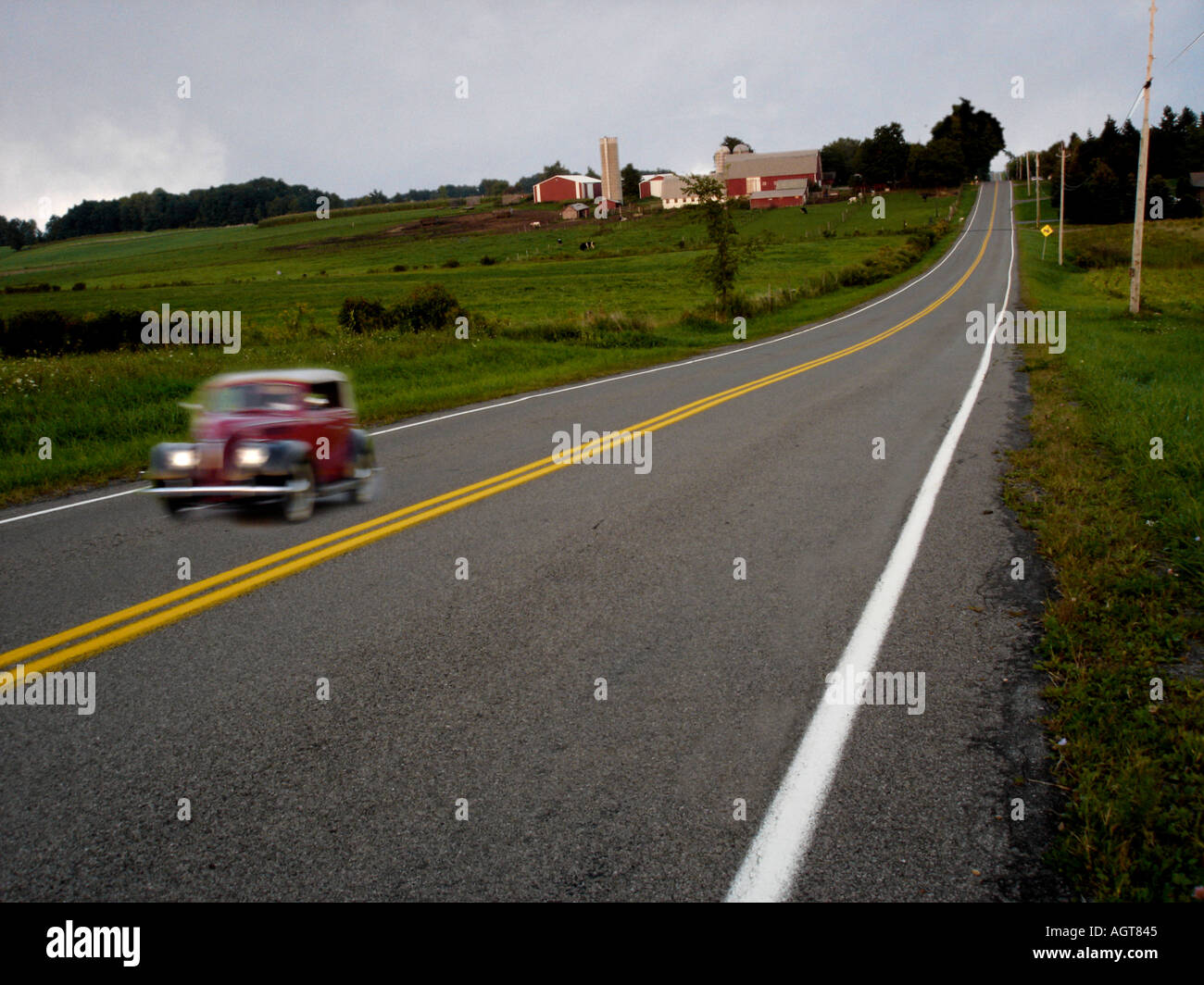 Vintage car on country road Stock Photo - Alamy