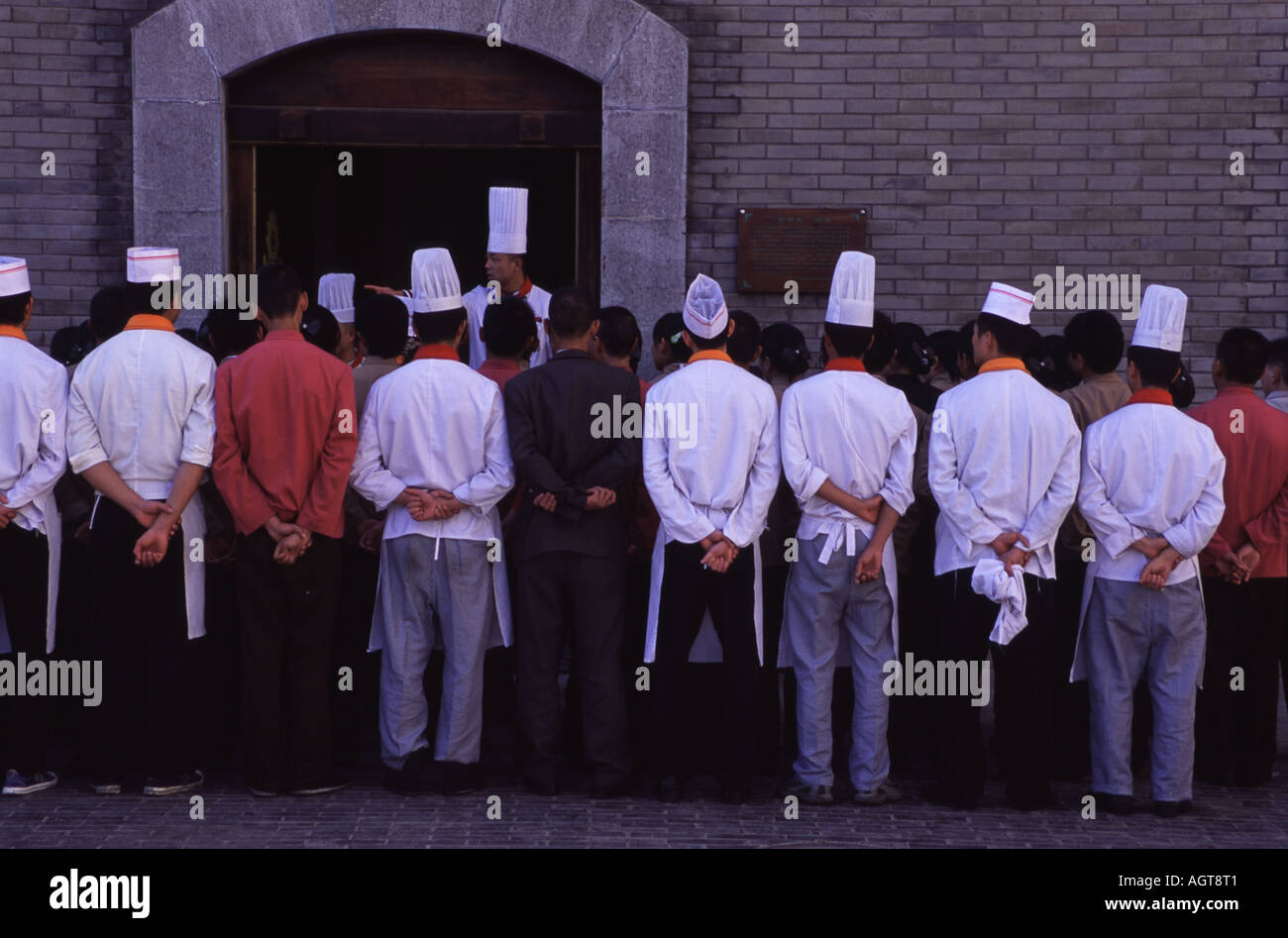 Kitchen staff outside a restaurant in Kuming China for their early ...