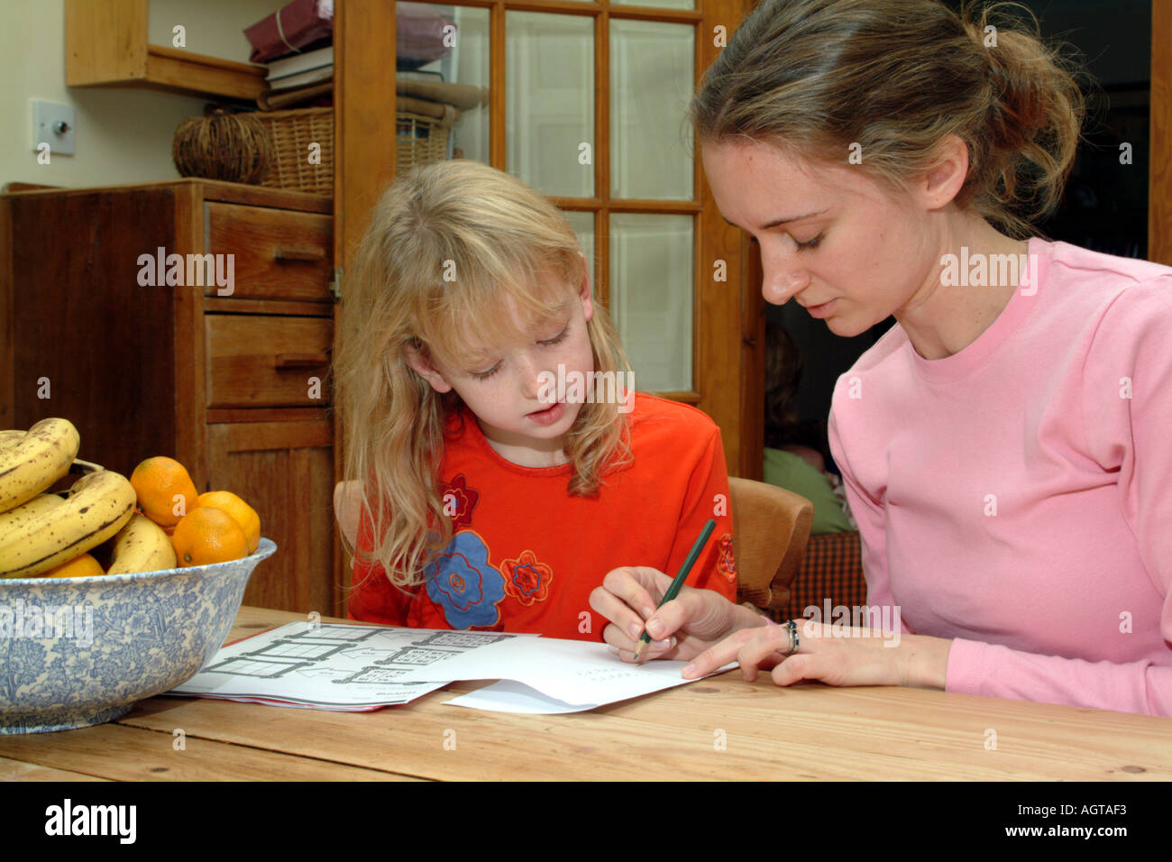 Little Girl gets help with her homework Stock Photo - Alamy
