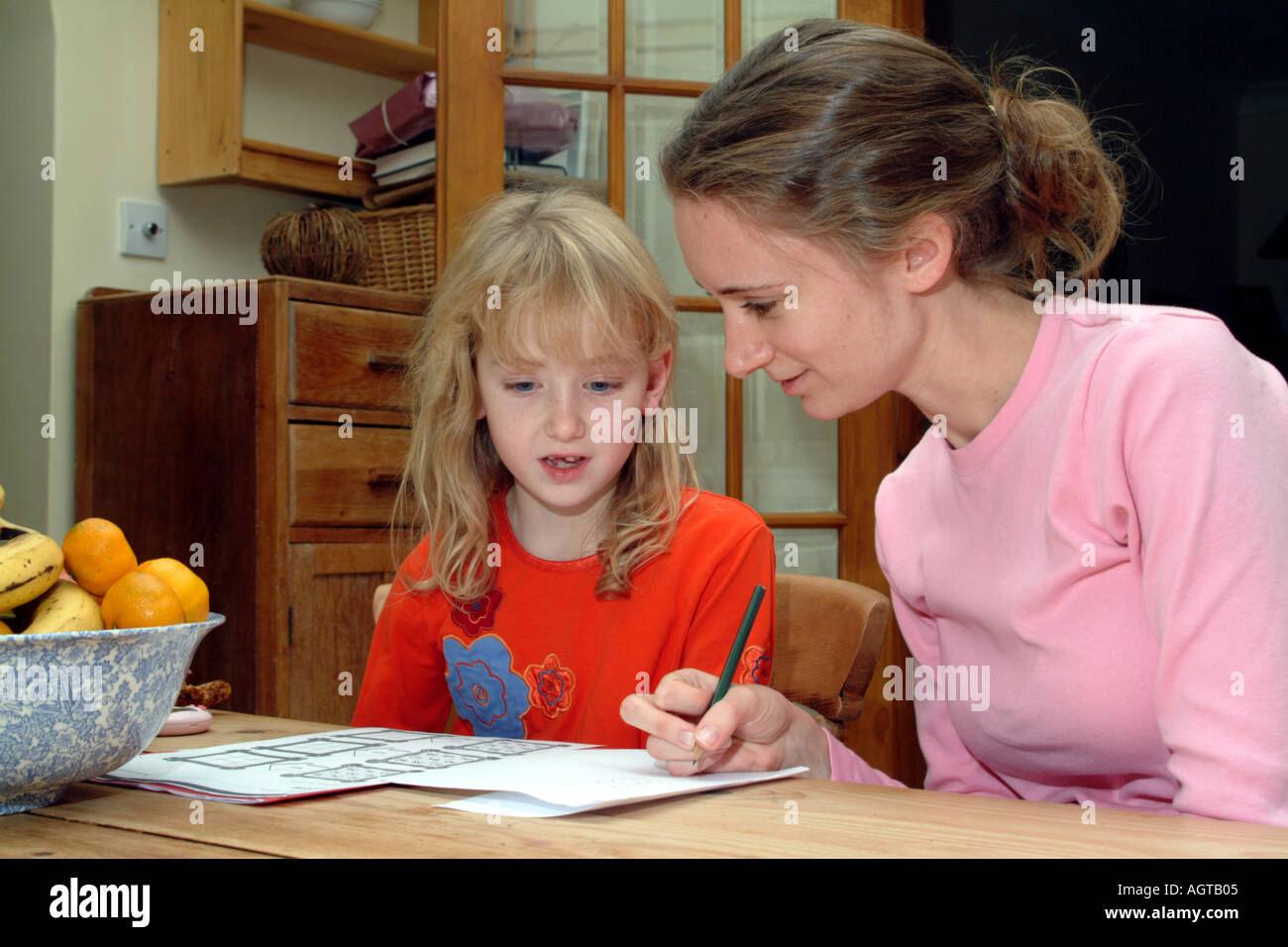 Little Girl gets help with her homework Stock Photo - Alamy
