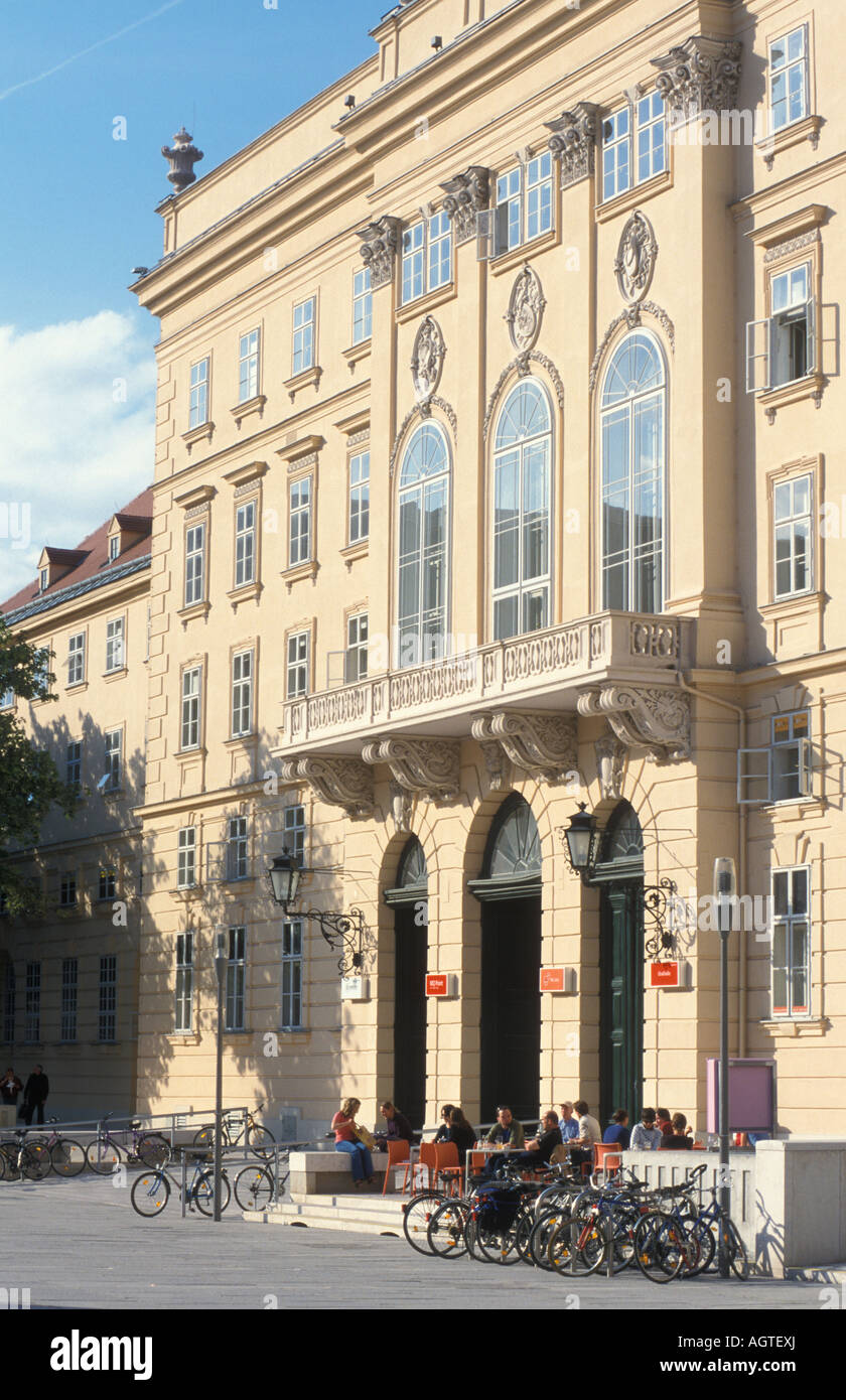People at a cafe in front of buildings of the baroque period at the ...