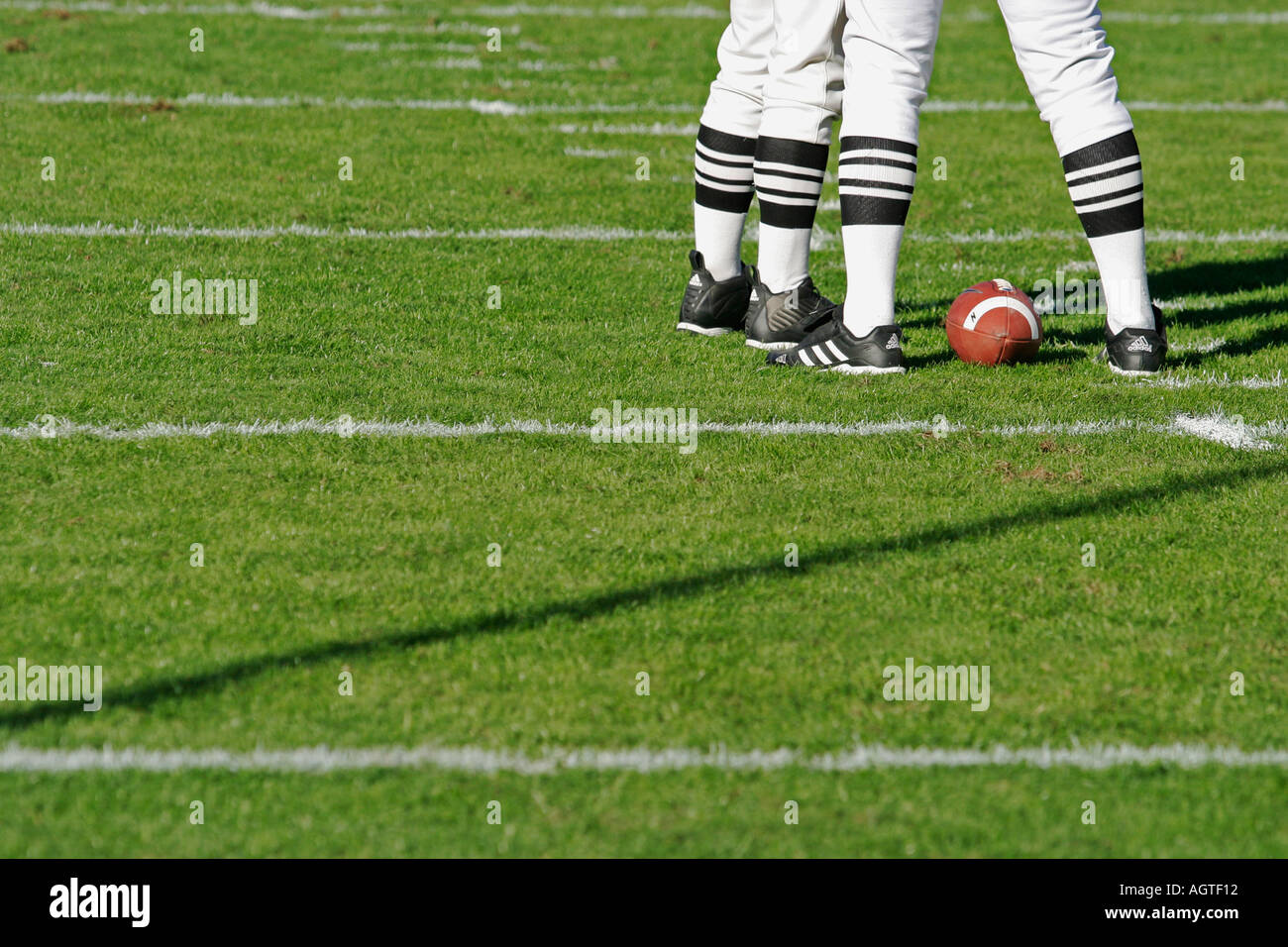 Image of two college football official s feet and the football during a ...