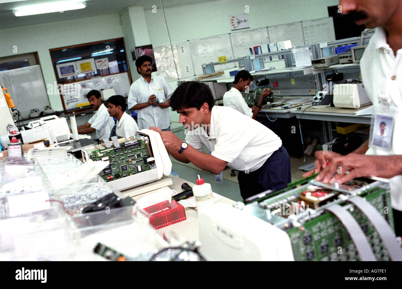 Worker putting together an ultra scanner machine at General Electric ...