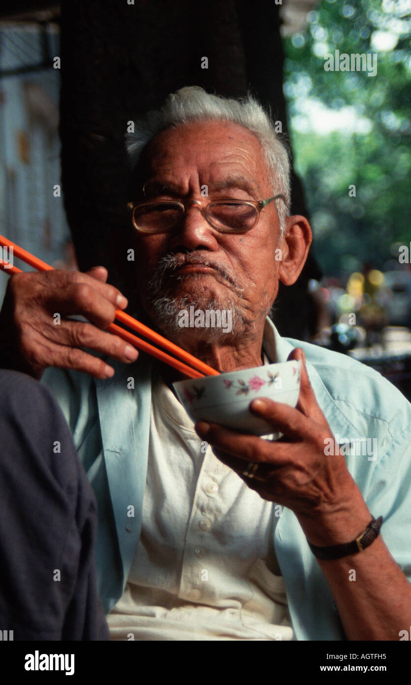 Man eating with chopsticks Stock Photo - Alamy